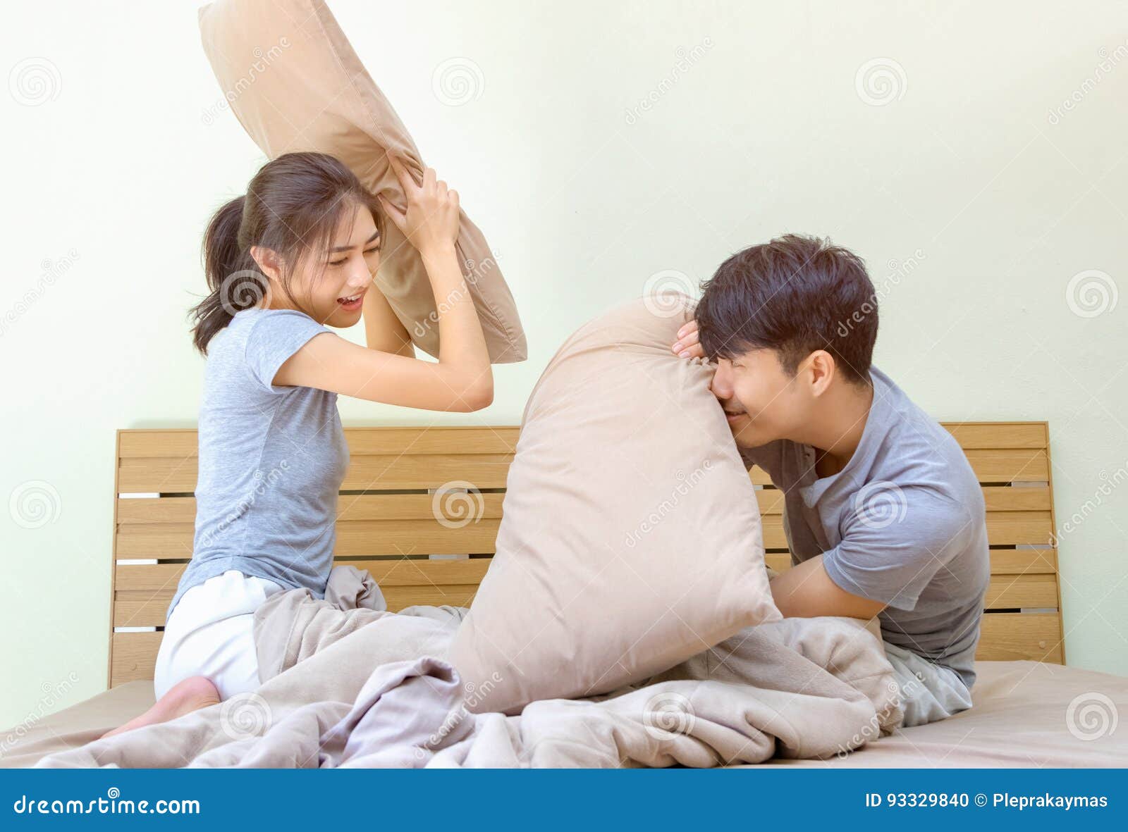 Couple Having Pillow Fight on Bed Stock Photo - Image of marriage ...