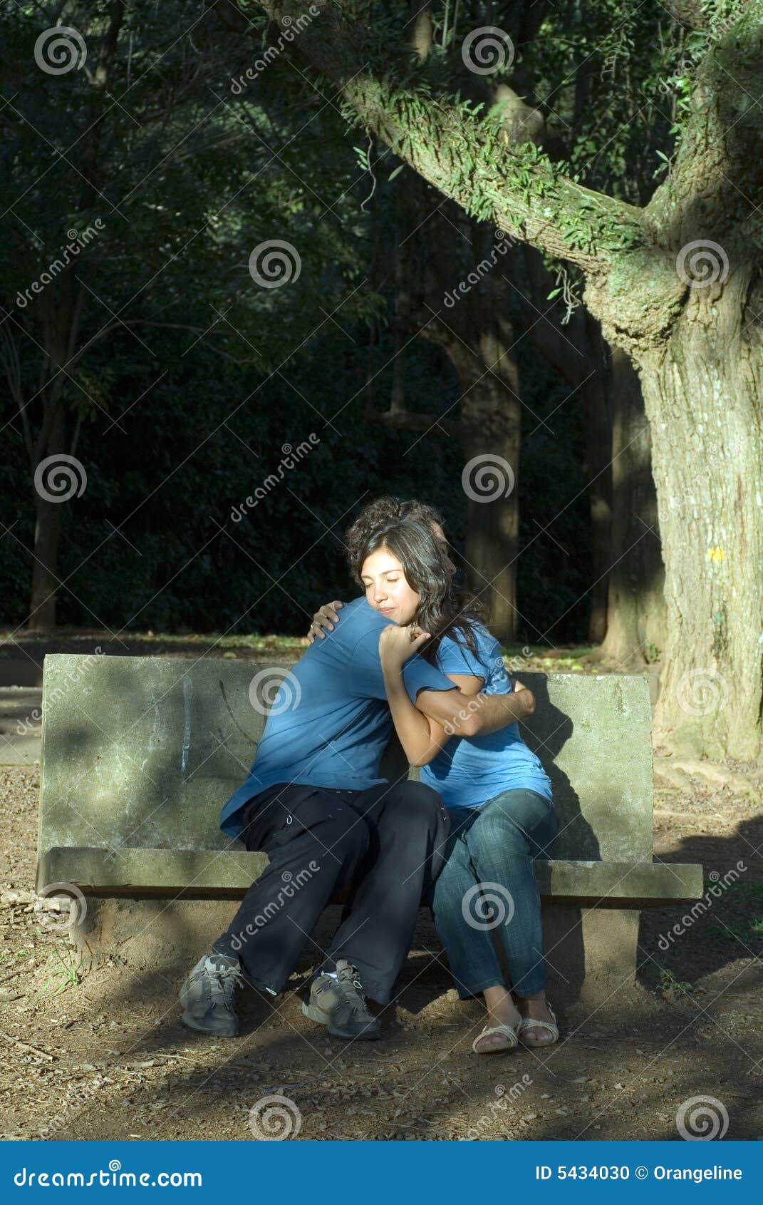 Happy Couple Hugging on a Bench - Vertical Stock Photo - Image of calm ...