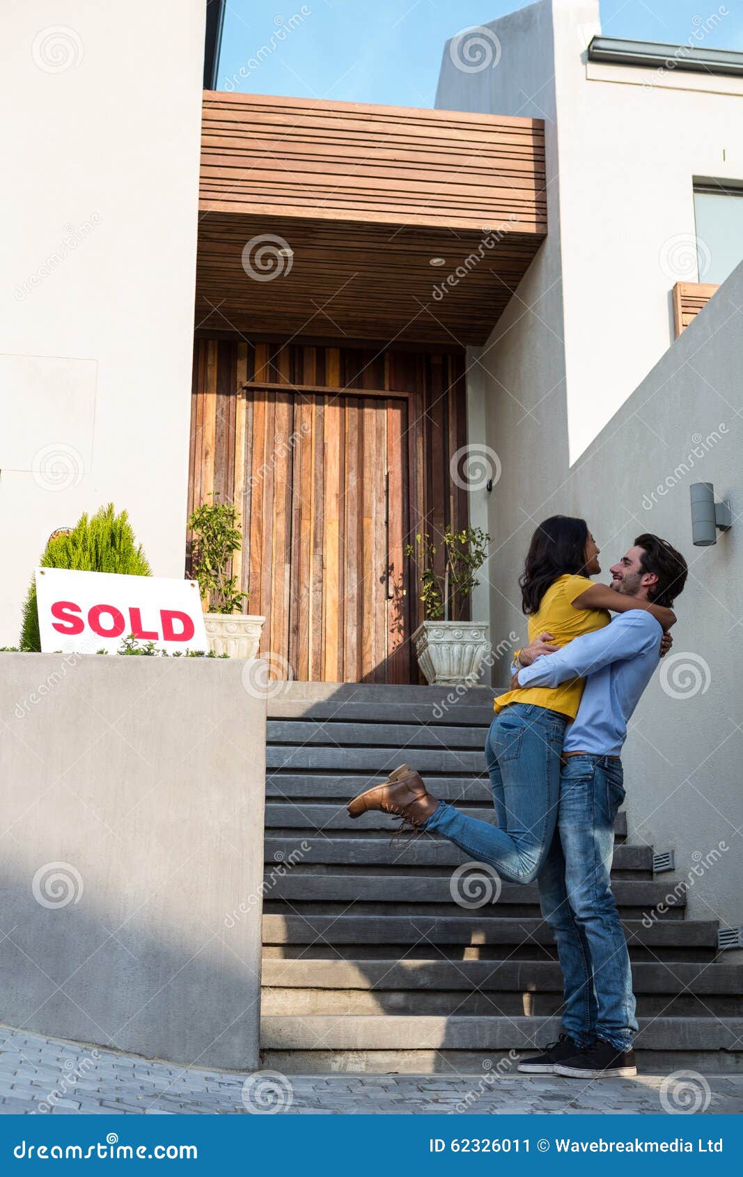 Happy Couple Hugging in Front of New House Stock Image - Image of happy ...