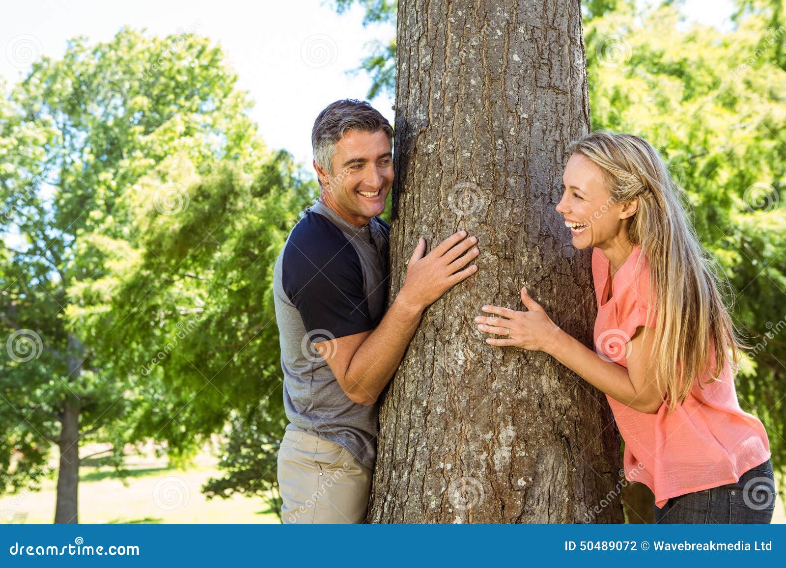 Happy Couple Hugging a Tree Stock Photo - Image of grass, nature: 50489072