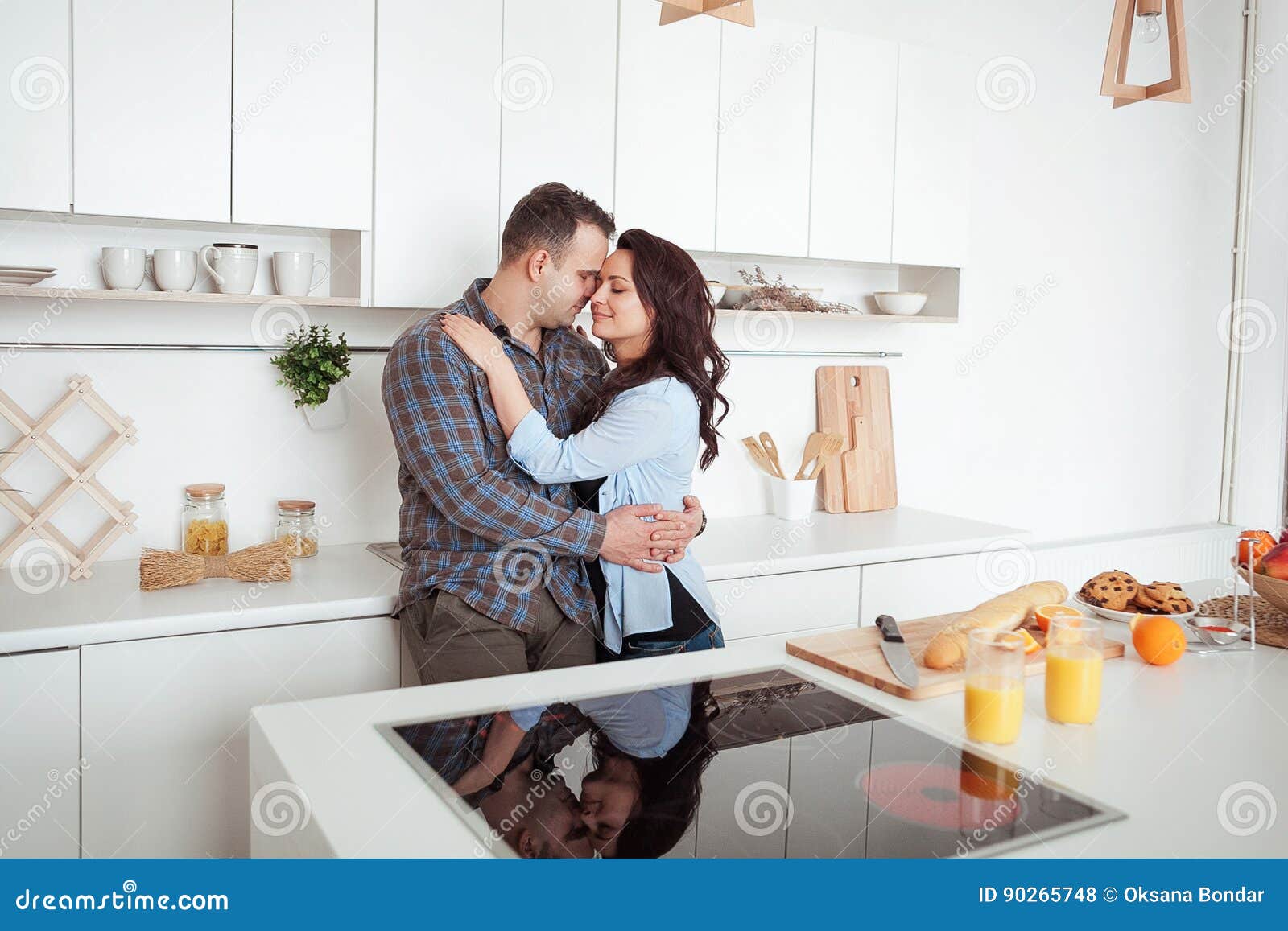 Happy Couple Hugging in the White Loft Stile Kitchen Stock Photo ...
