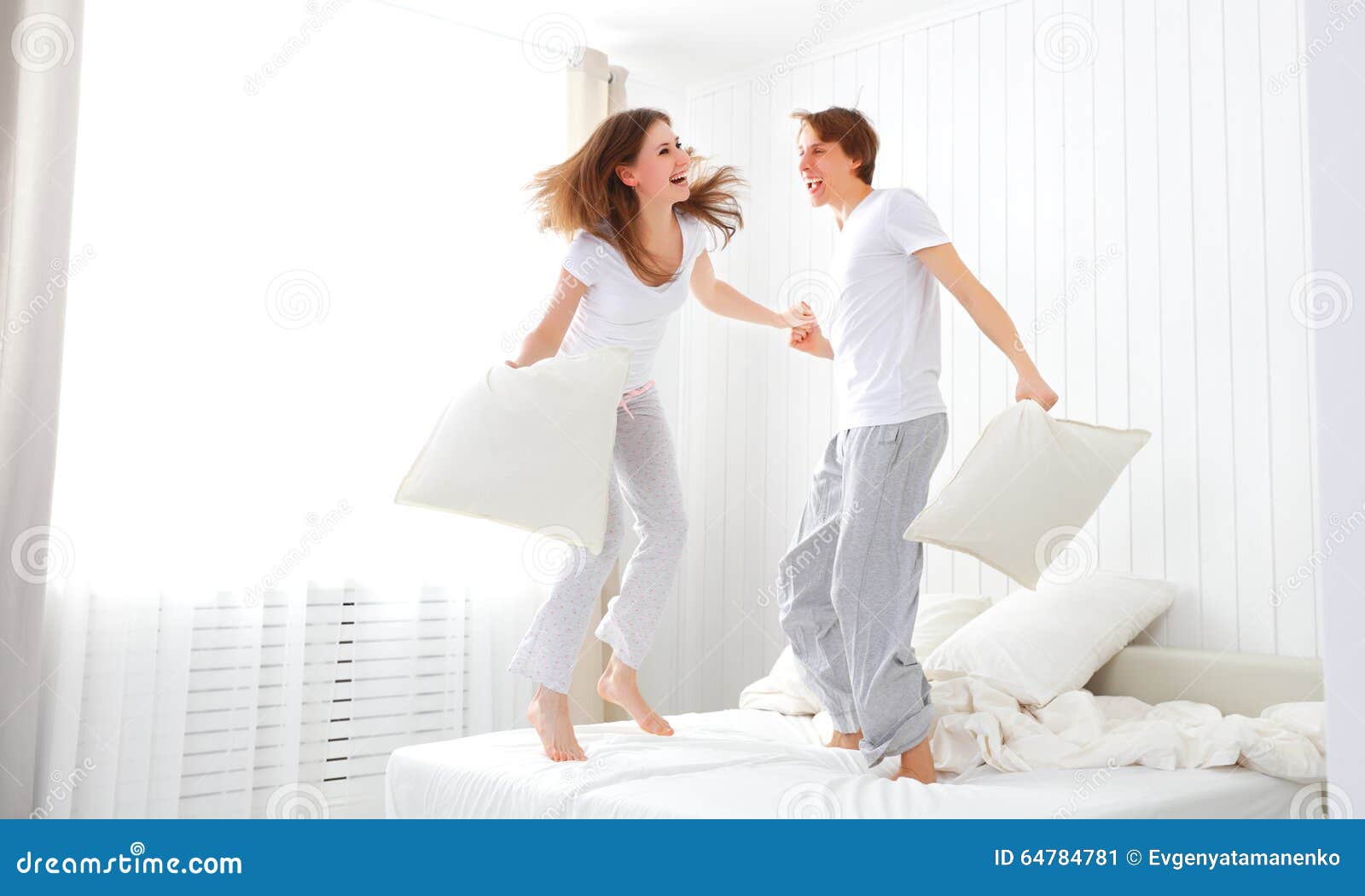 Happy Couple Jumping and Having Fun in Bed Stock Image - Image of ...