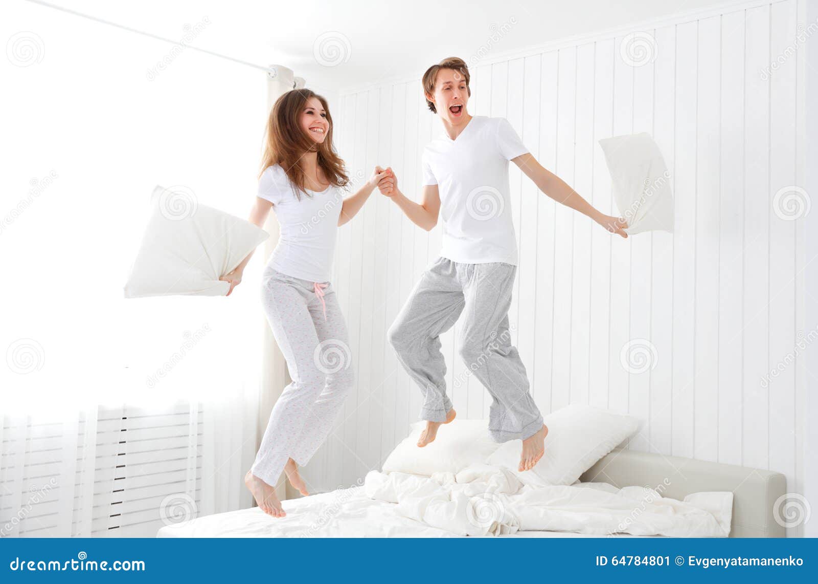Happy Couple Jumping and Having Fun in Bed Stock Image - Image of ...
