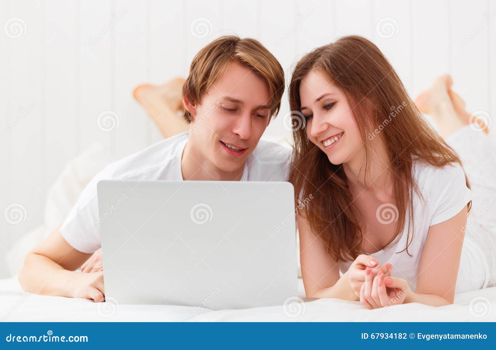 Happy Couple with Laptop on Internet in Bed Stock Photo - Image of ...