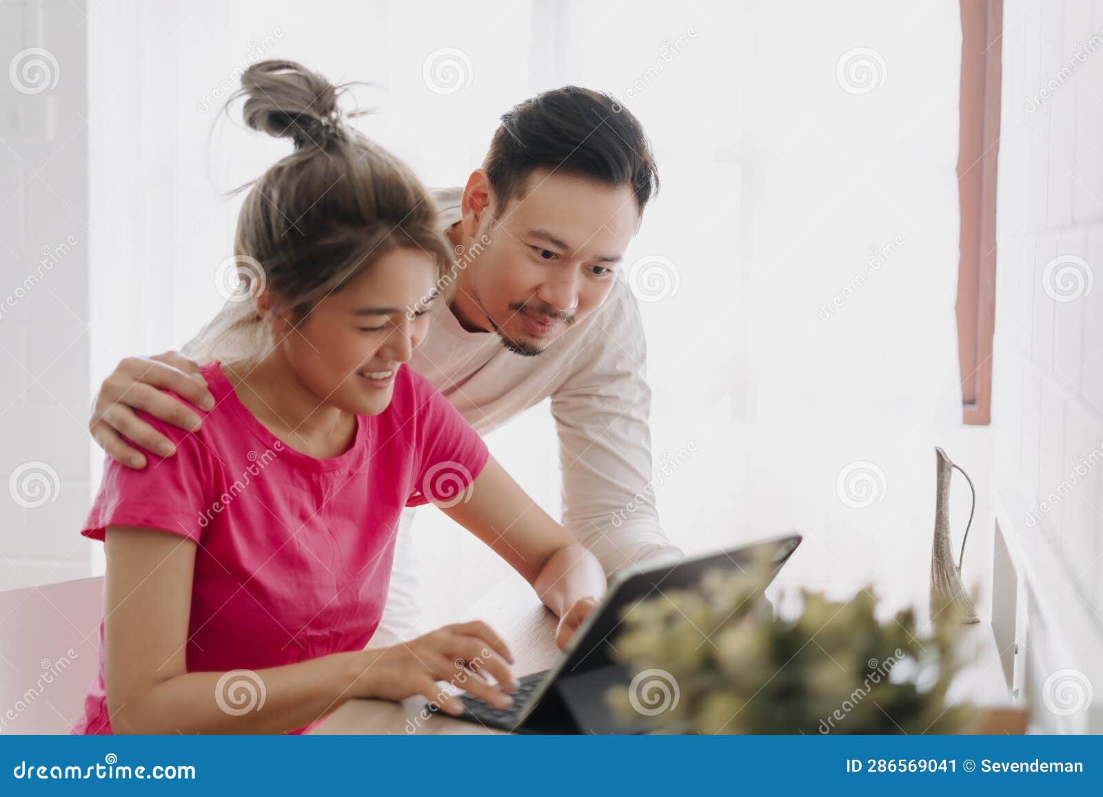 Happy Couple Looking at the Advertisement Service Offer in the Internet ...