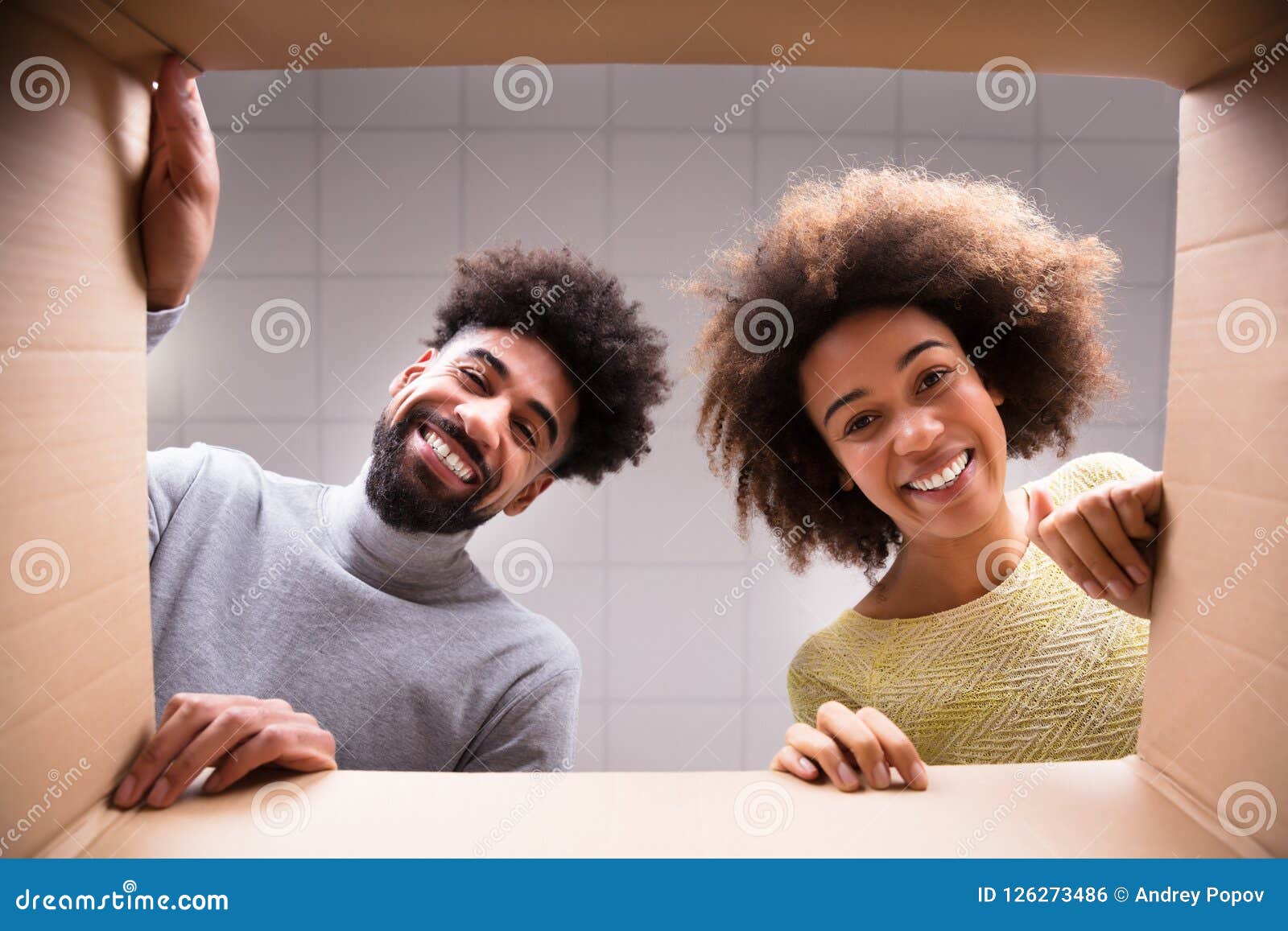Happy Couple Looking Inside Cardboard Box Stock Photo - Image of ...