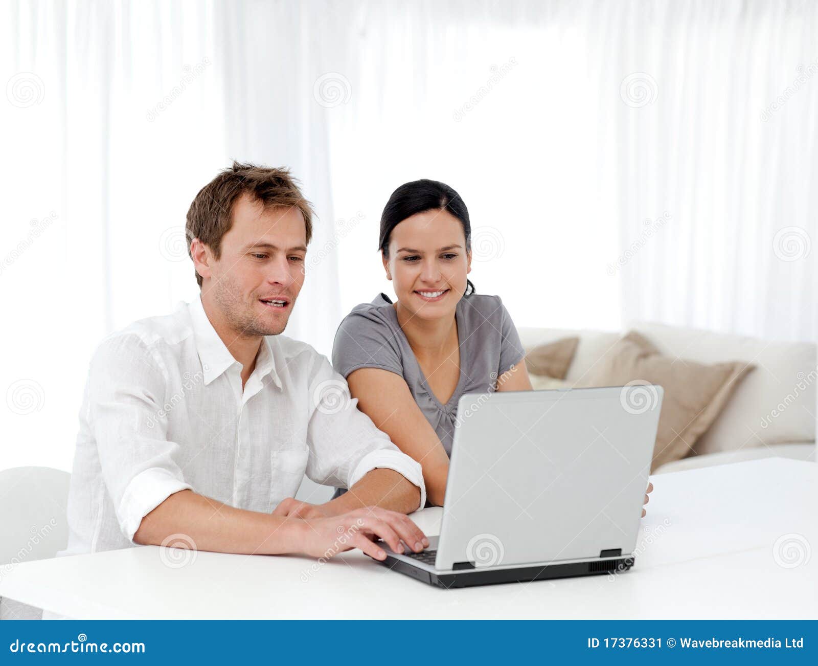 Happy Couple Looking at Something on the Laptop Stock Image - Image of ...