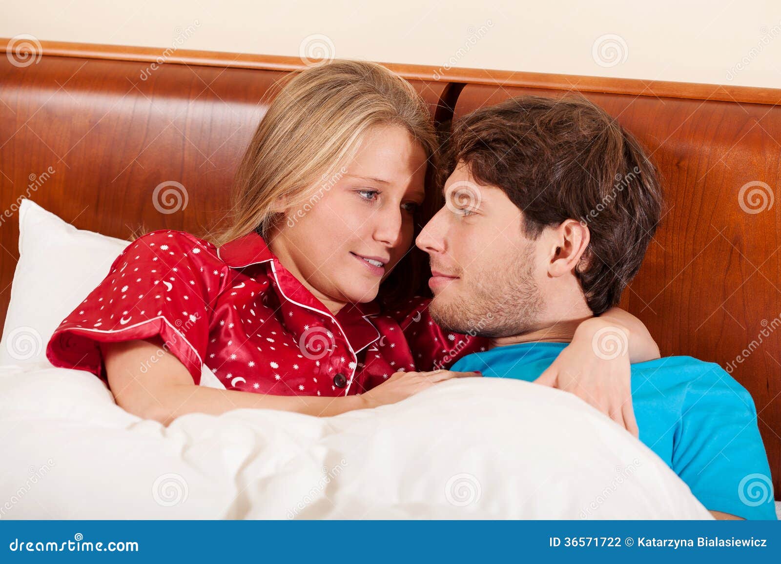 Happy couple lying in bed stock photo. Image of morning - 36571722