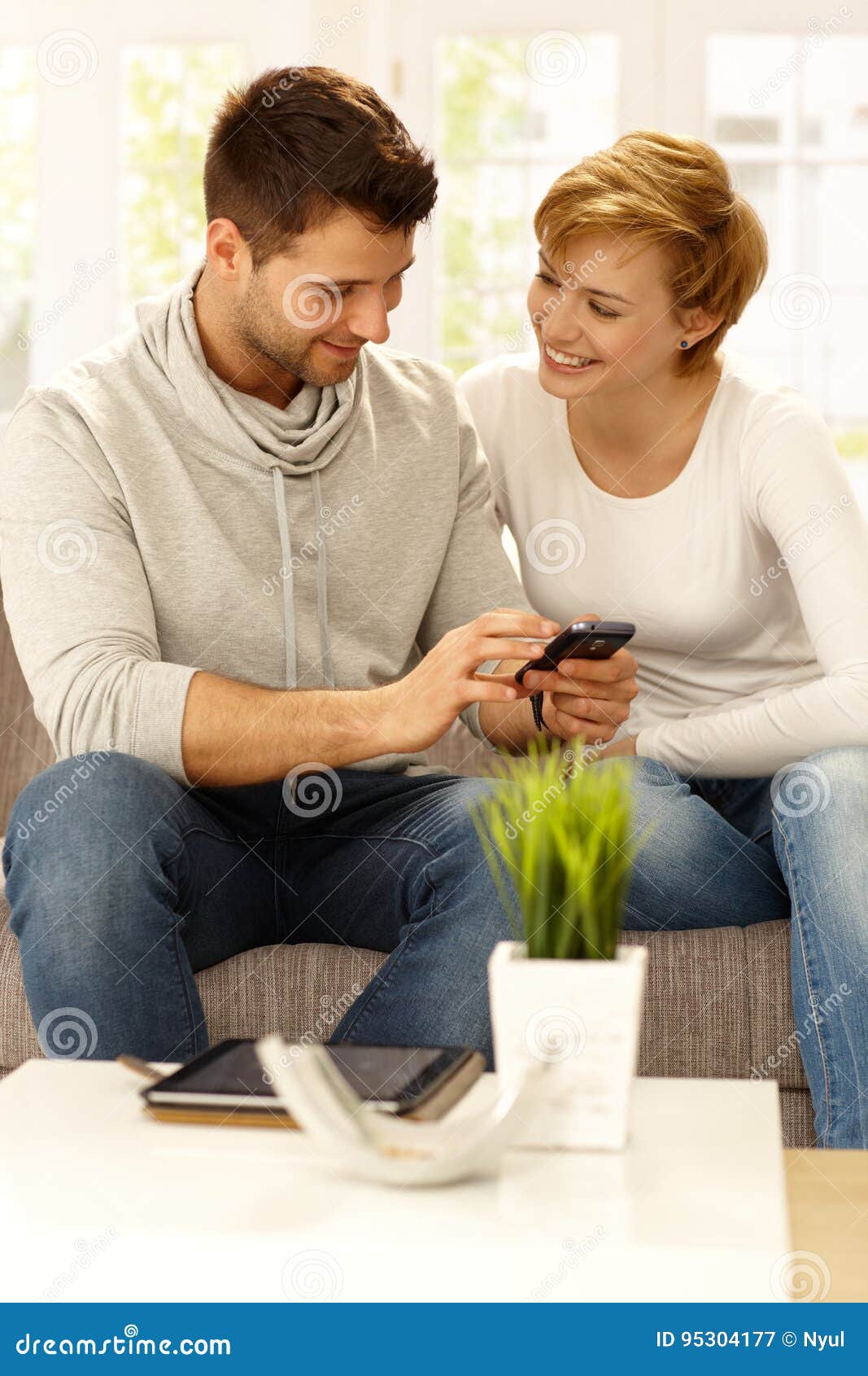 Happy couple with mobile stock image. Image of cheerful - 95304177