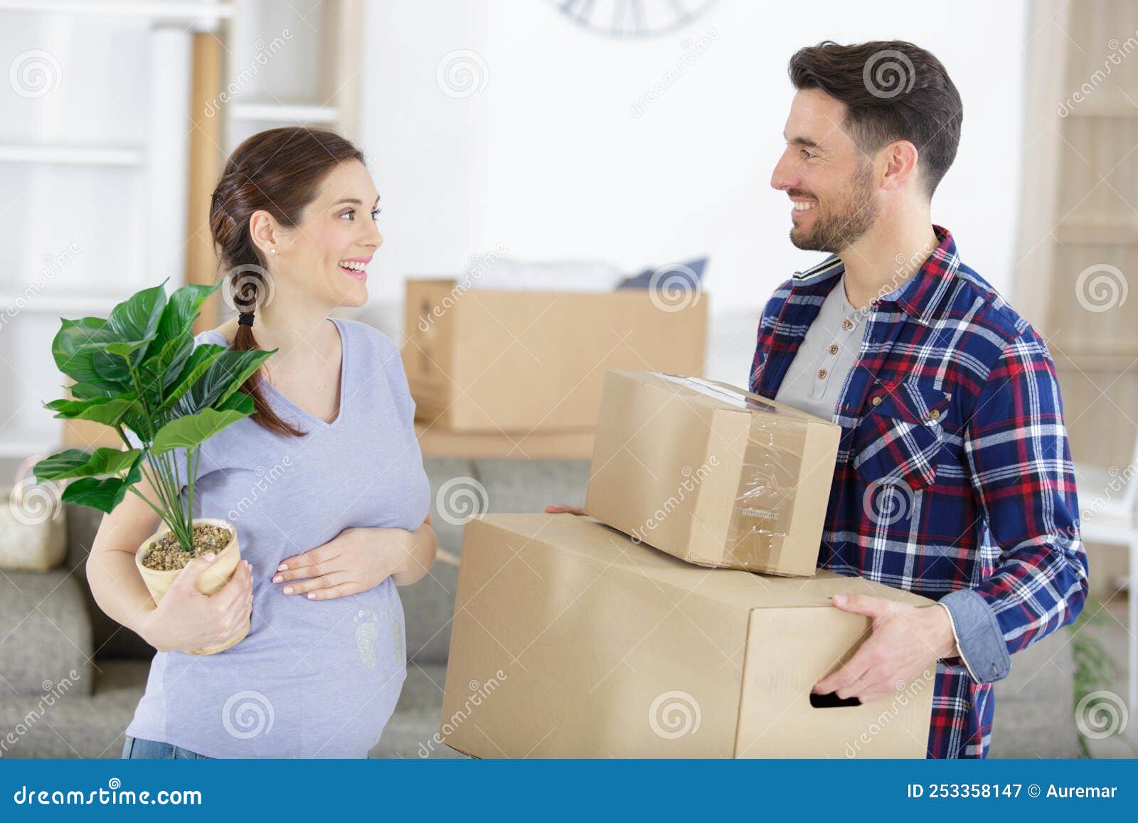 Happy couple moving home stock image. Image of indoor - 253358147