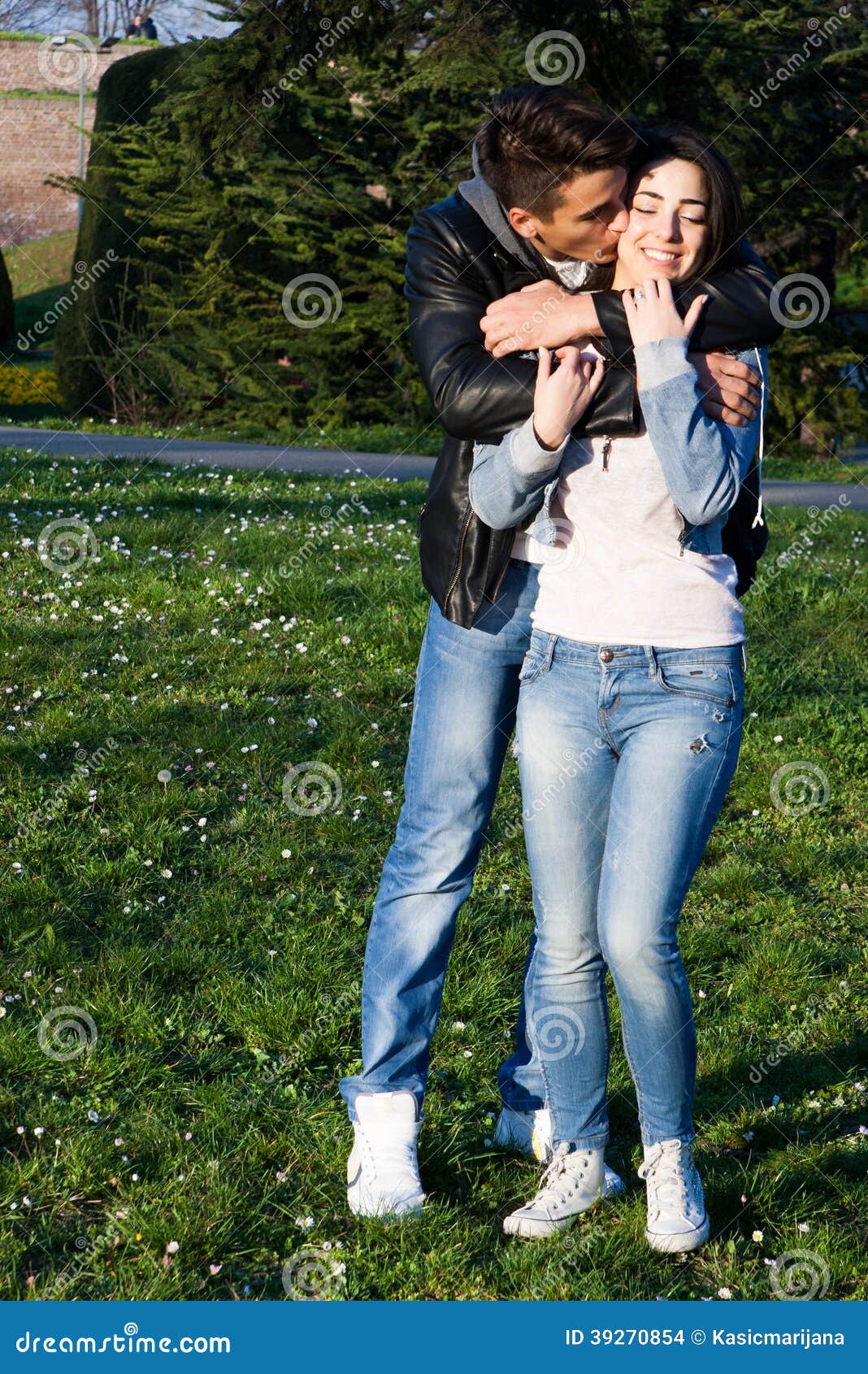 Happy Couple in a Park Hugging Stock Photo - Image of bright ...