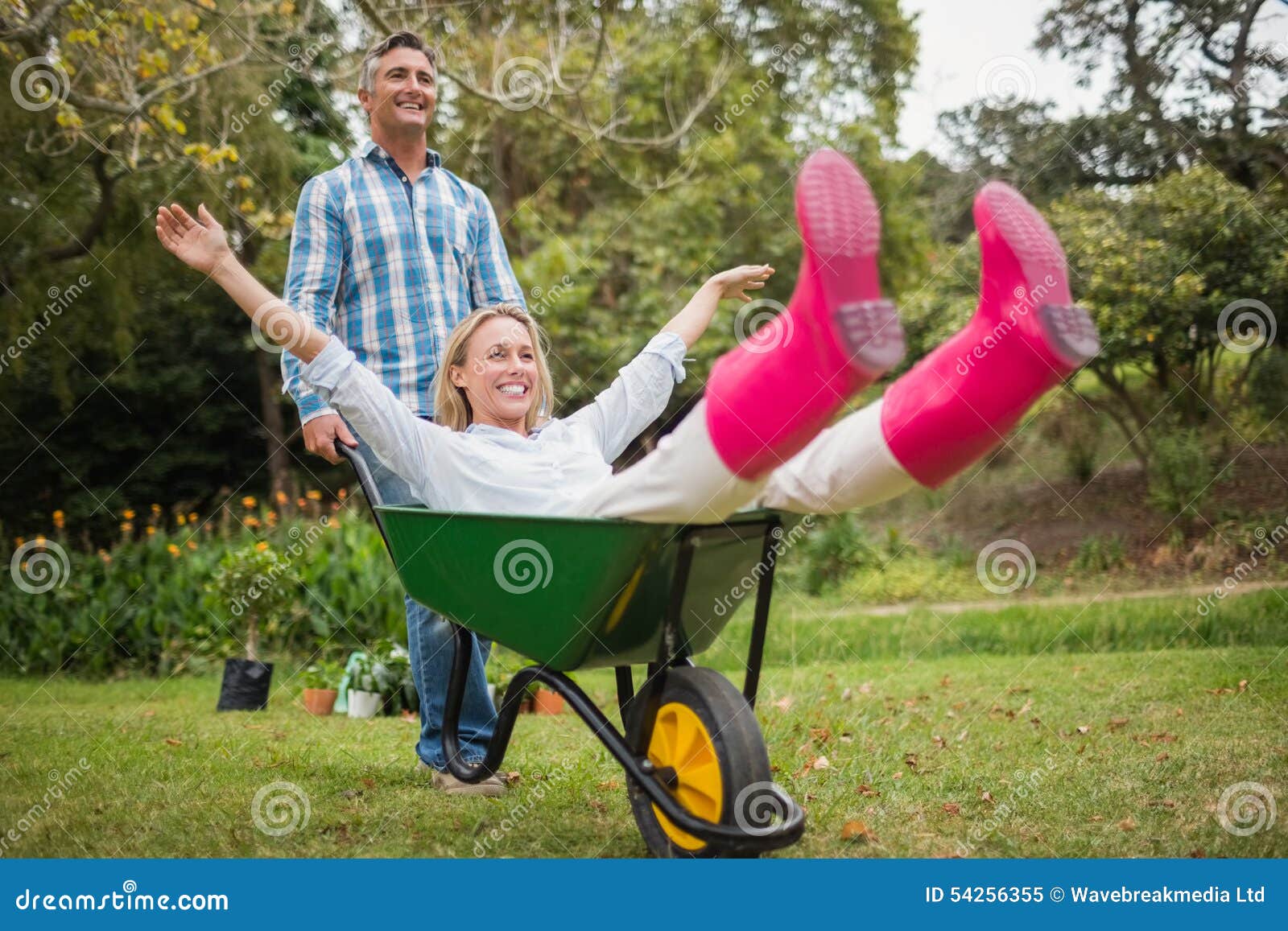 Happy Couple Playing with a Wheelbarrow Stock Image - Image of living ...