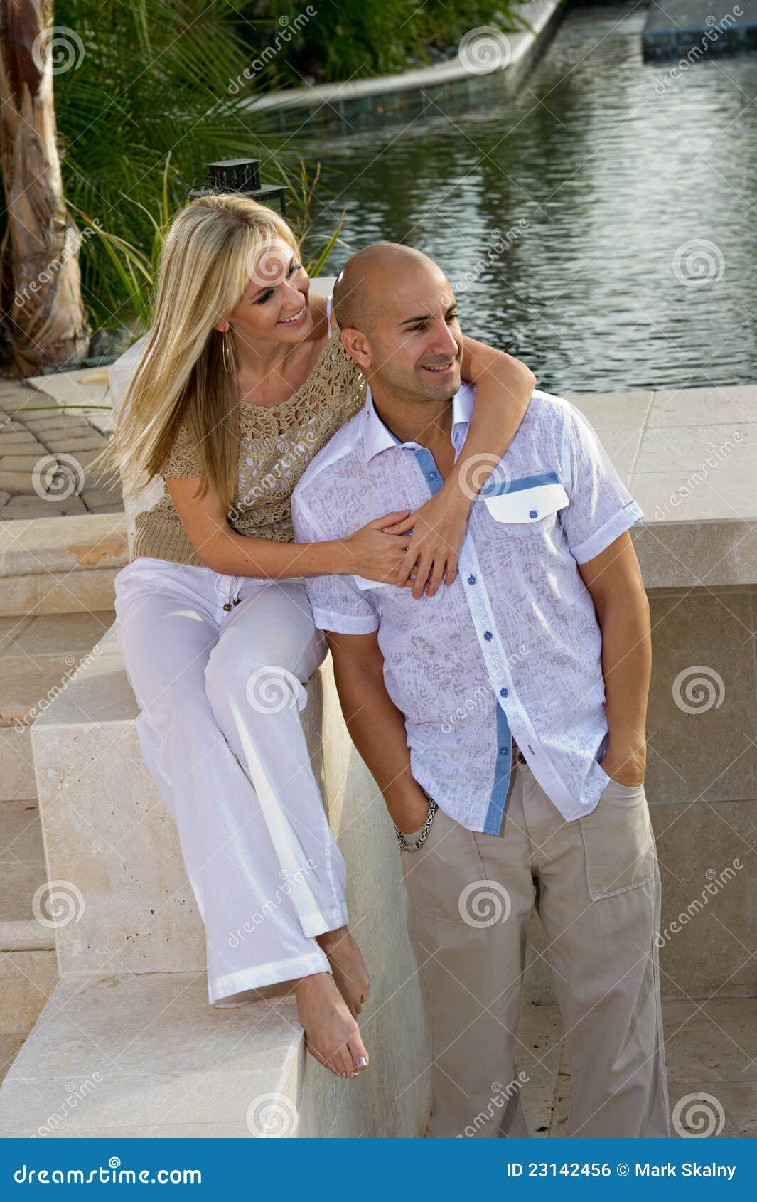 Happy couple by the pool stock photo. Image of attractive - 23142456