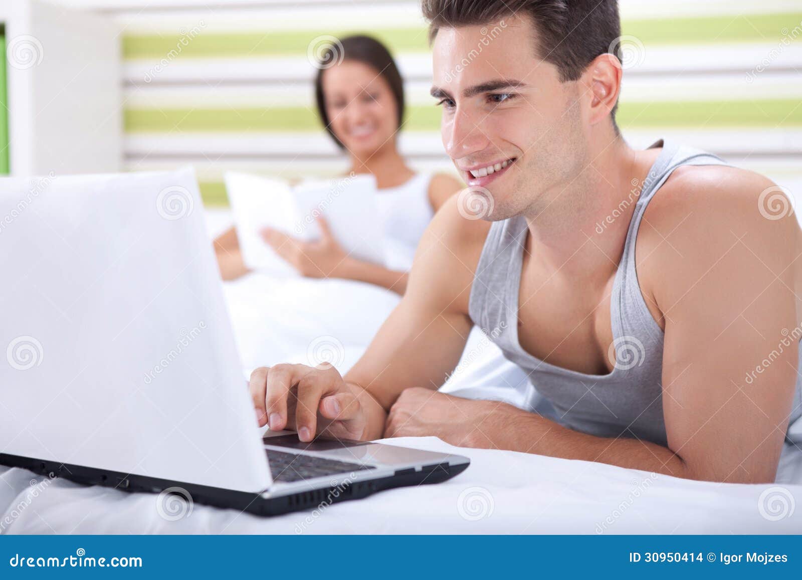 Happy Couple Relaxing in Bed Stock Photo - Image of book, husband: 30950414