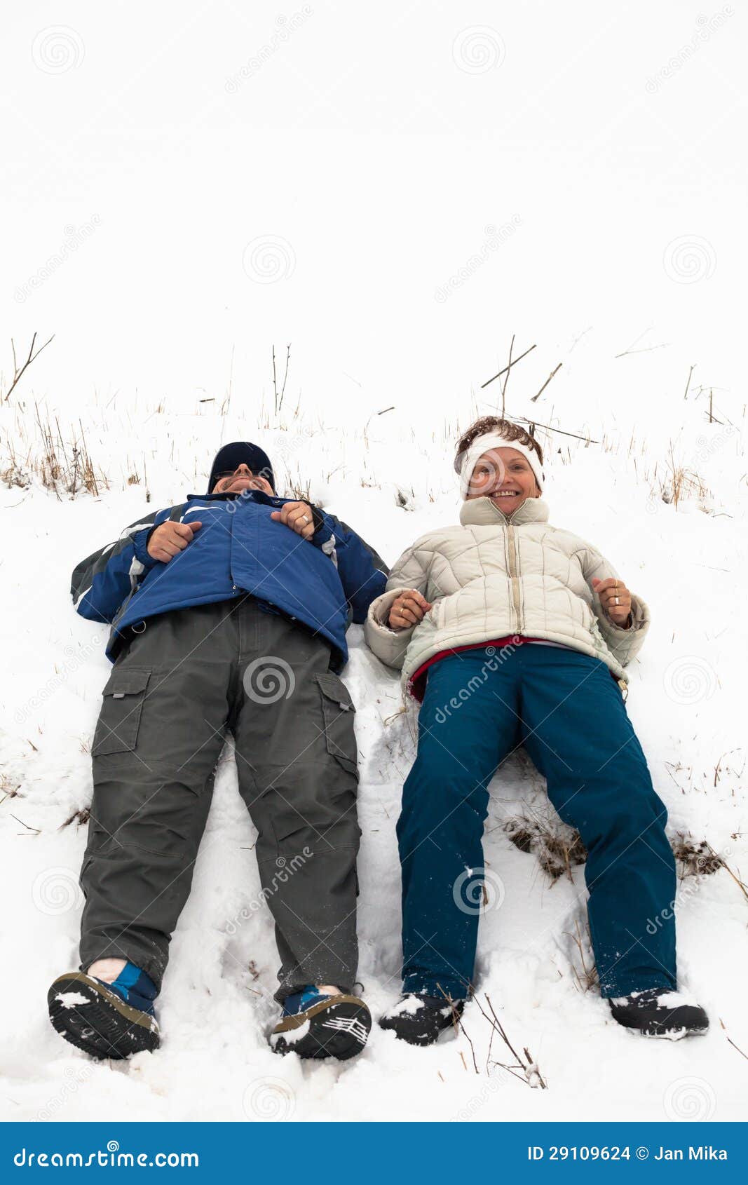 Happy Couple Resting on Snow Stock Photo - Image of laying, nature ...