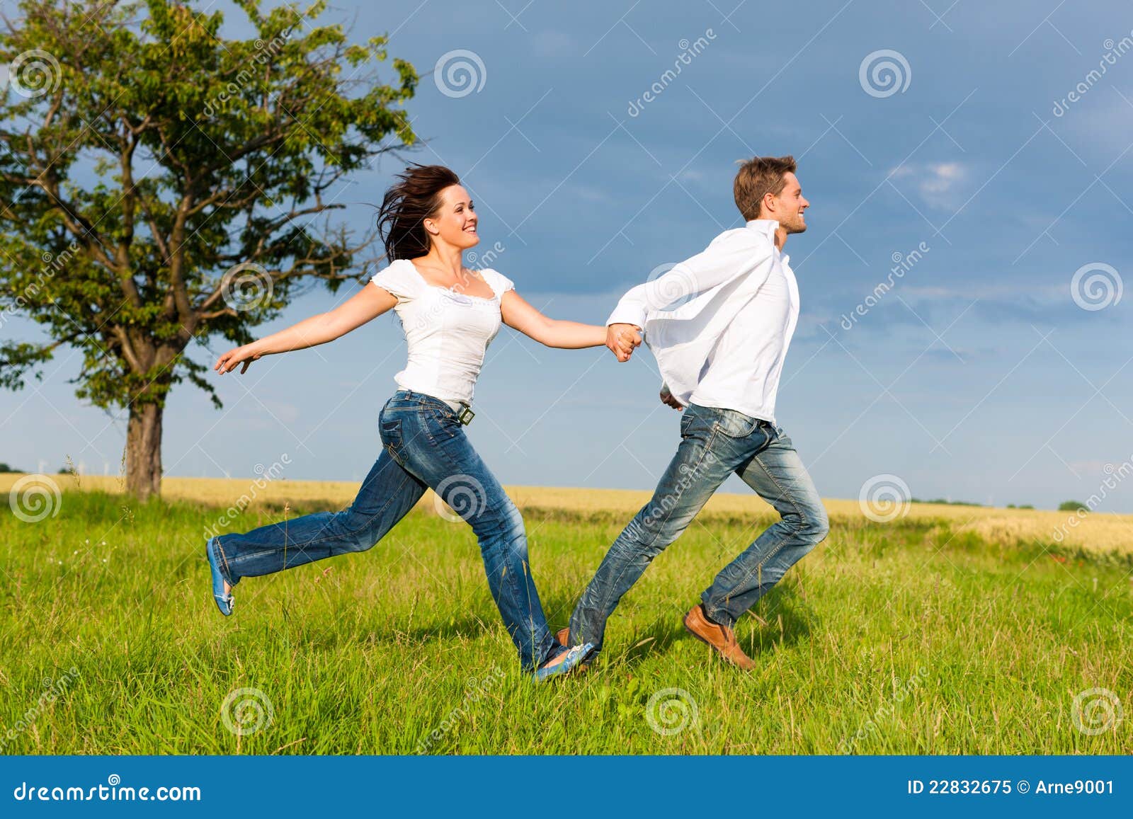 Happy Couple Running on a Meadow Stock Image - Image of grass, green ...