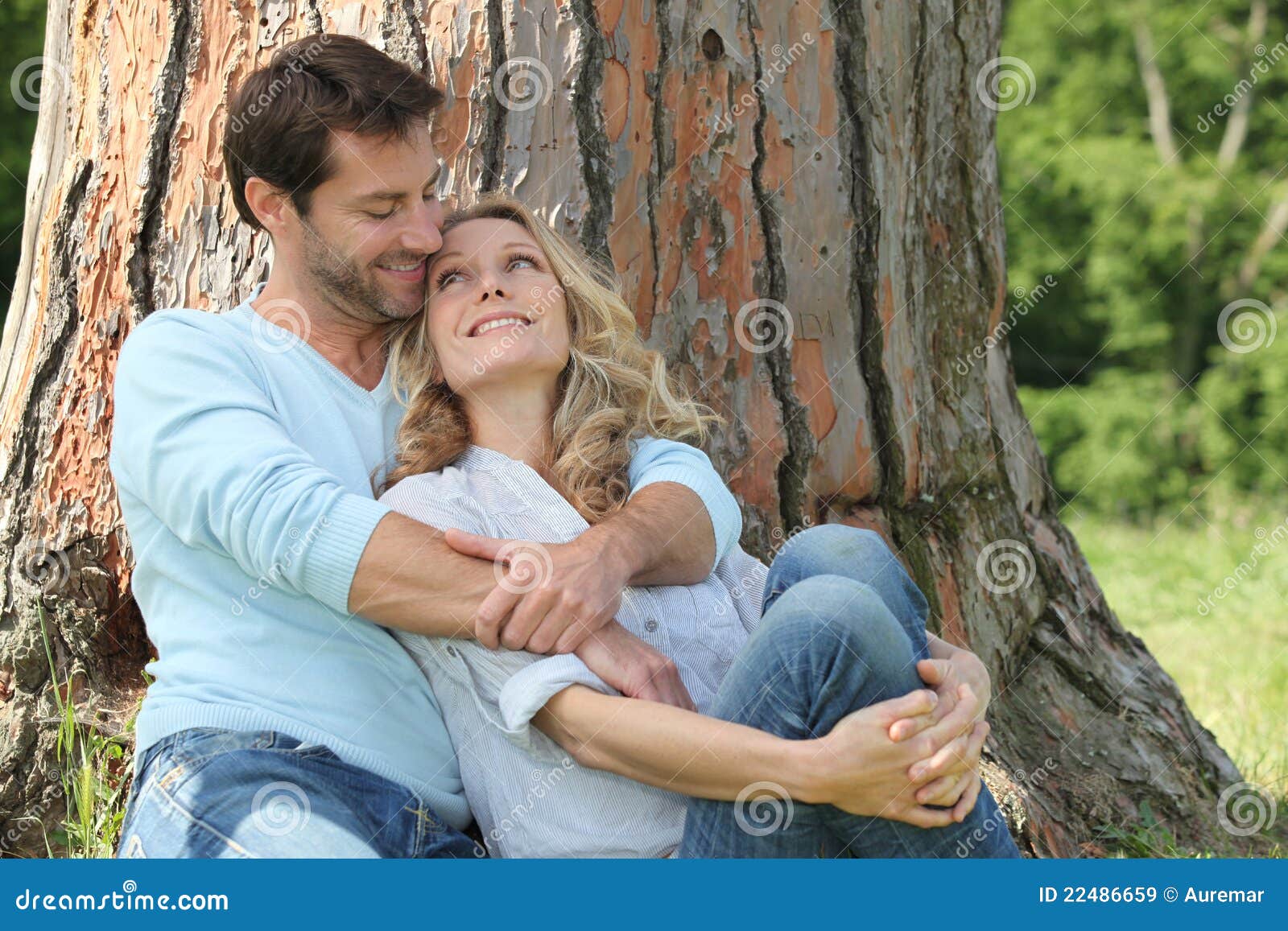 Happy couple sat by tree stock image. Image of relaxation - 22486659