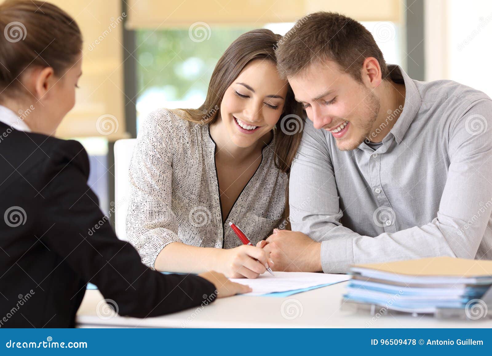Happy Couple Signing a Contract at Office Stock Photo - Image of ...
