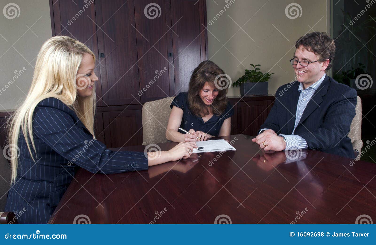Happy Couple Signing Documents with Advisor Stock Photo - Image of ...