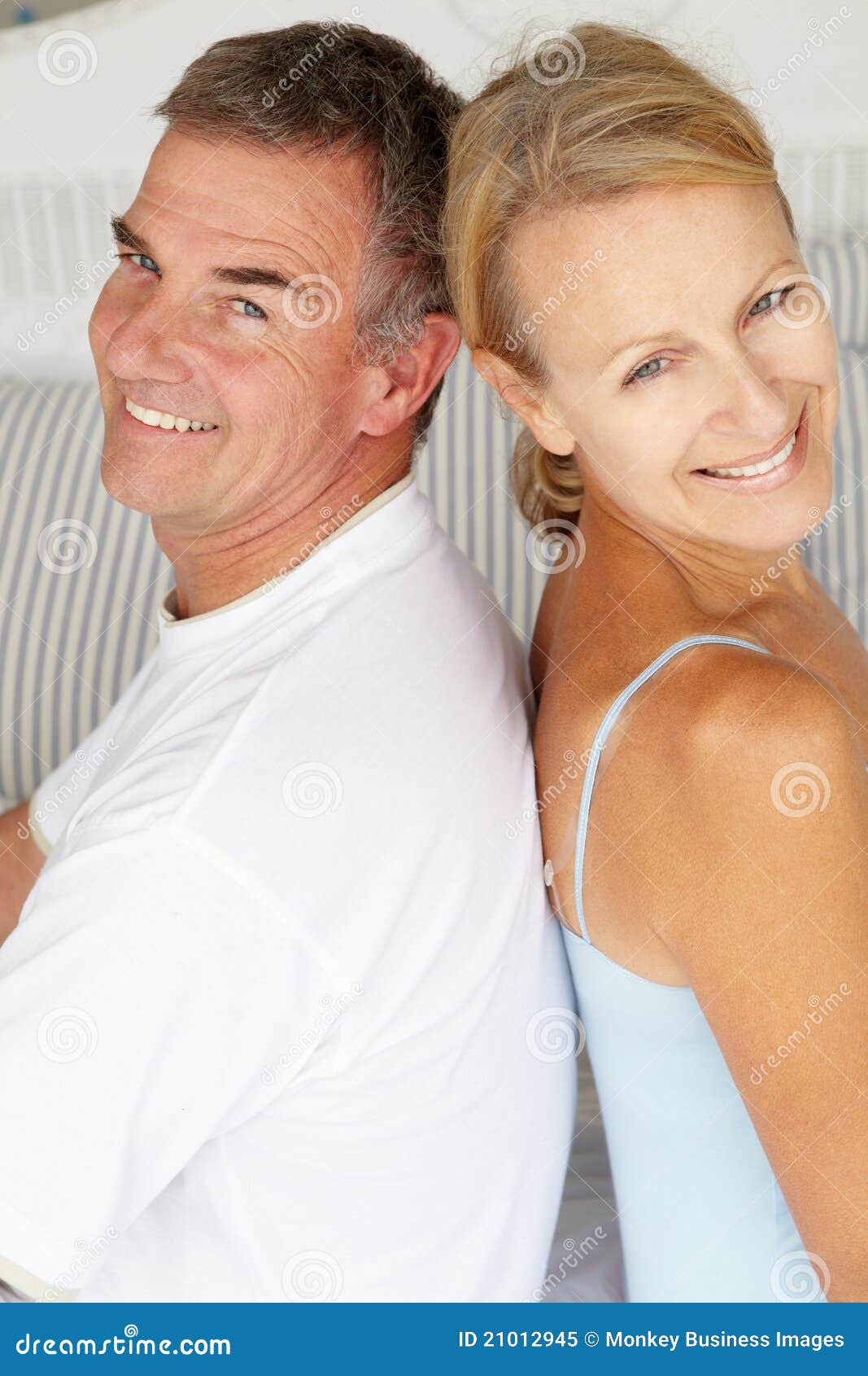 Happy Couple Sitting Back To Back Stock Image - Image of forties ...
