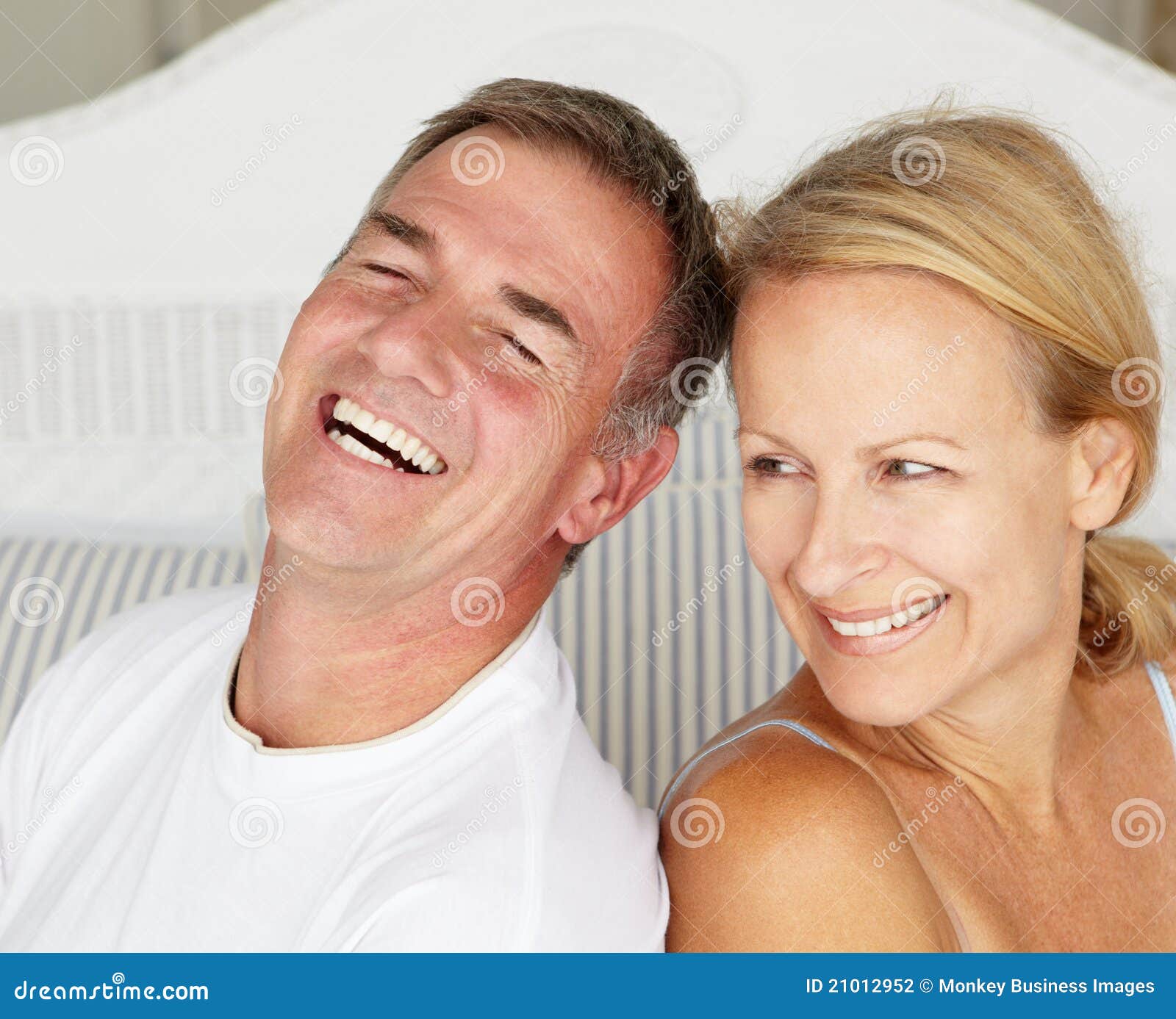 Happy Couple Sitting Back To Back on Bed Stock Photo - Image of male ...