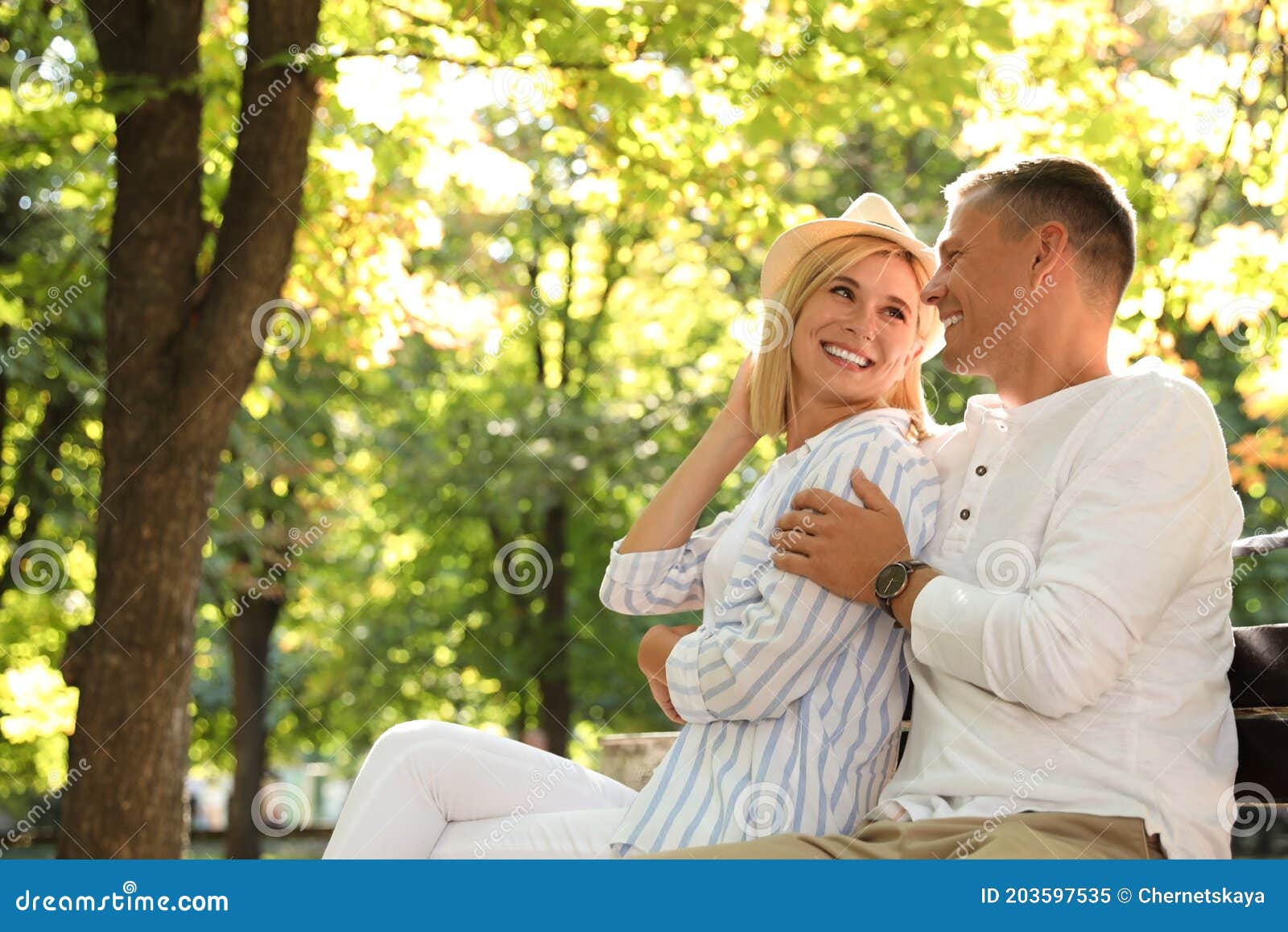Happy Couple Sitting on Bench in Summer Park Stock Image - Image of ...