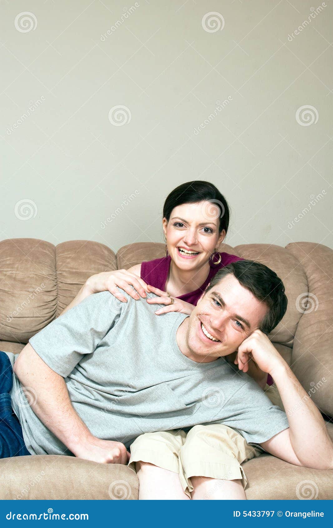 Happy, Couple Sitting on a Couch - Vertical Stock Image - Image of ...