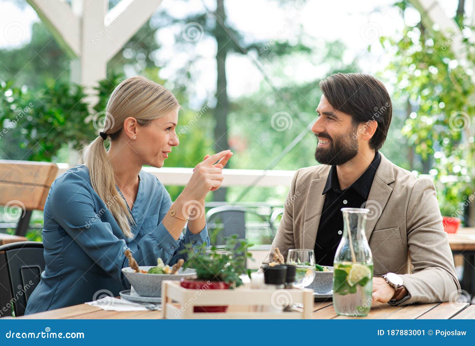 Happy Couple Sitting Outdoors on Terrace Restaurant, Talking. Stock ...