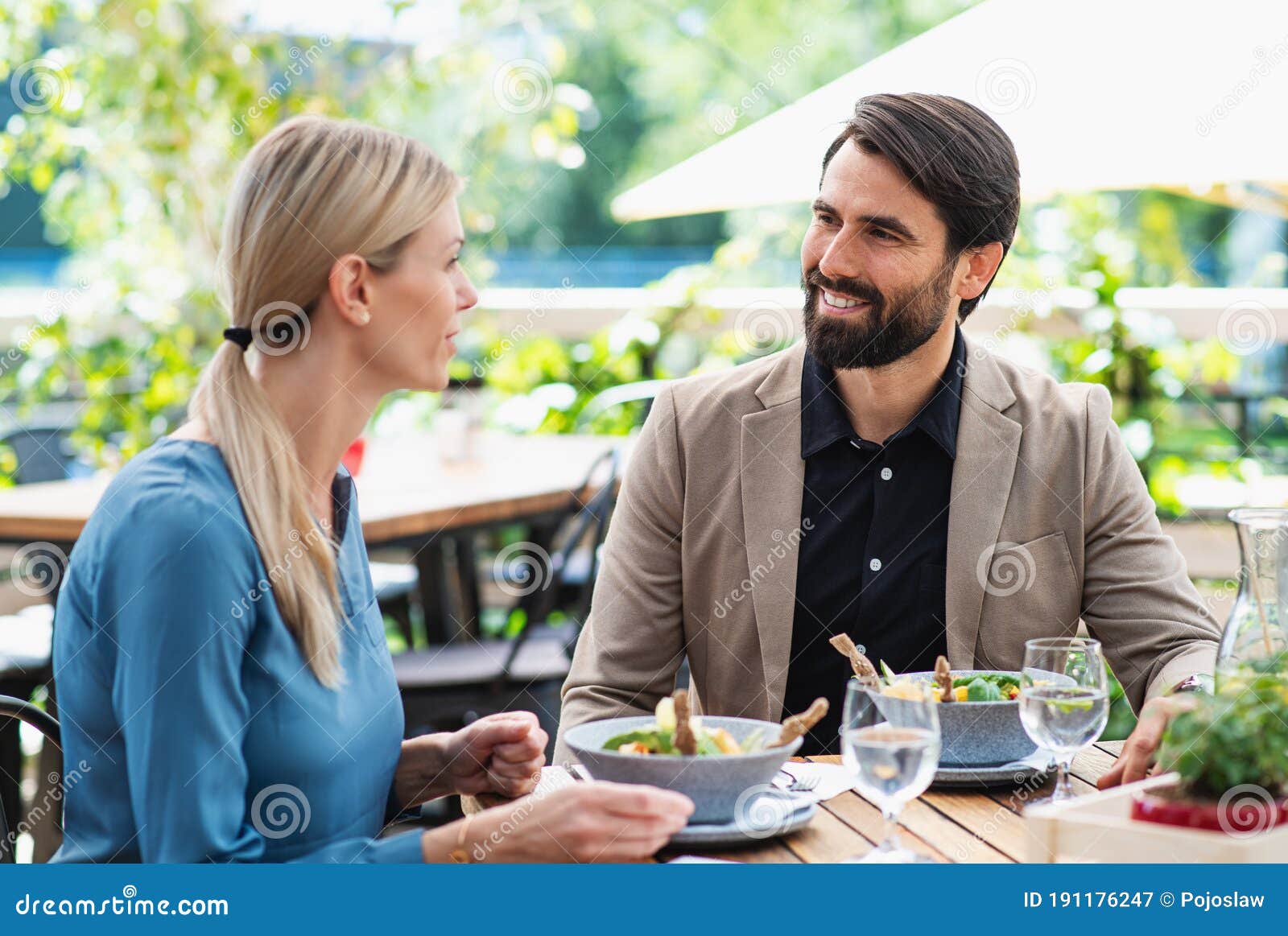 Happy Couple Sitting Outdoors on Terrace Restaurant, Talking. Stock ...