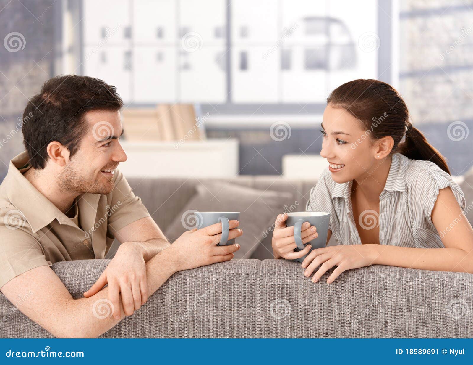 Happy Couple Sitting on Sofa Drinking Tea Smiling Stock Image - Image ...