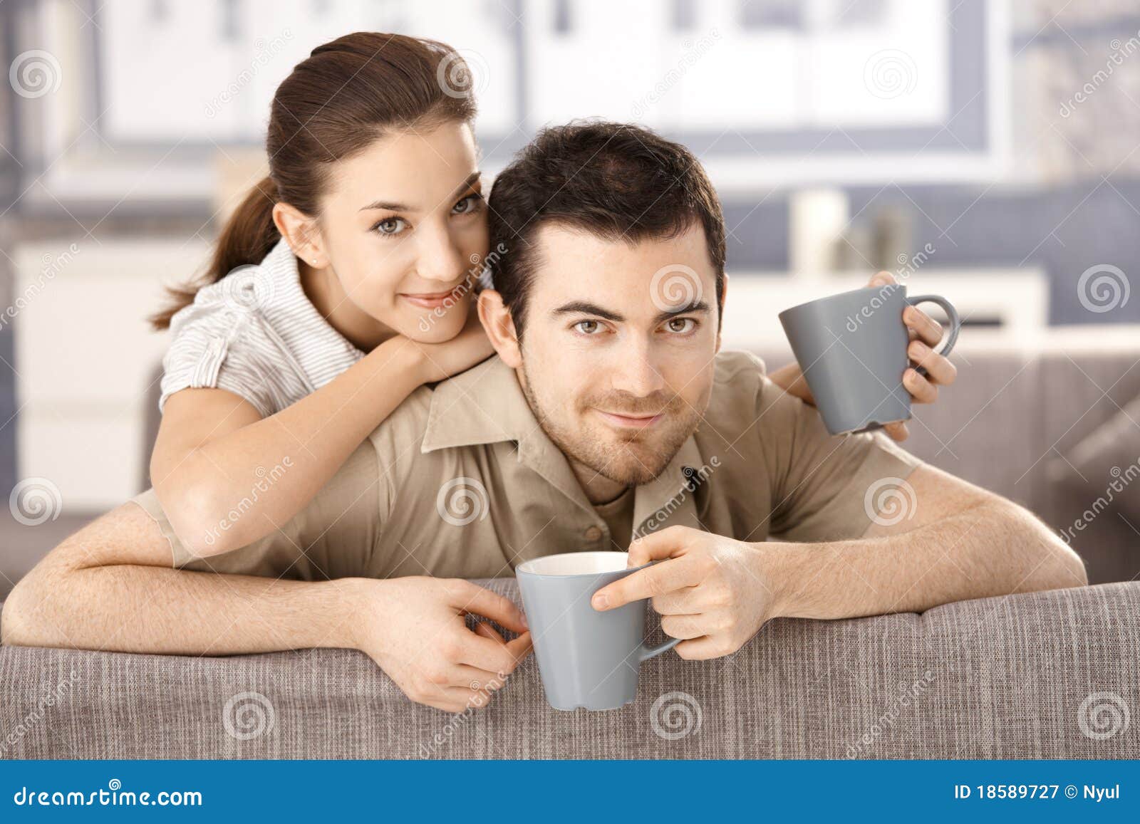 Happy Couple Sitting on Sofa in Harmony Stock Image - Image of brunette ...