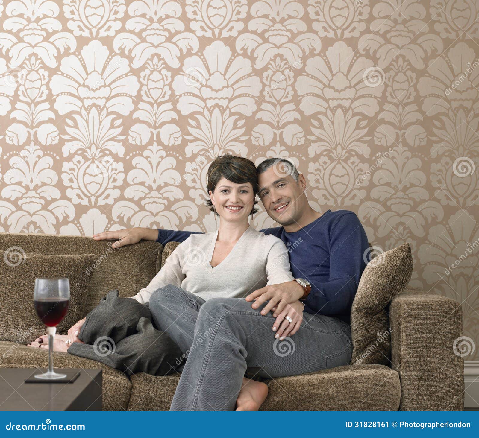 Happy Couple Sitting on Sofa Stock Image - Image of middle, adult: 31828161