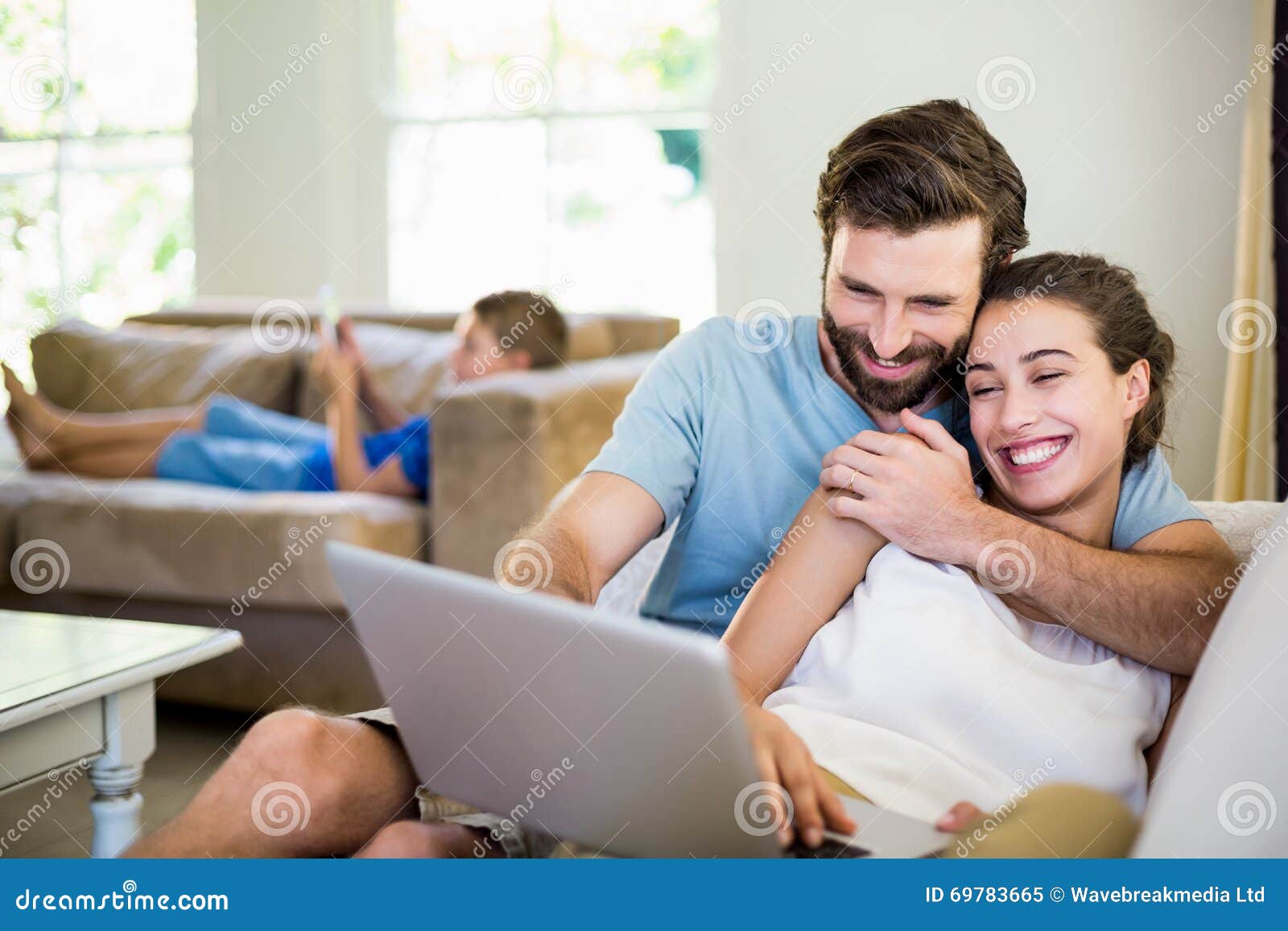 Happy Couple Sitting on Sofa and Using Laptop Stock Image - Image of ...