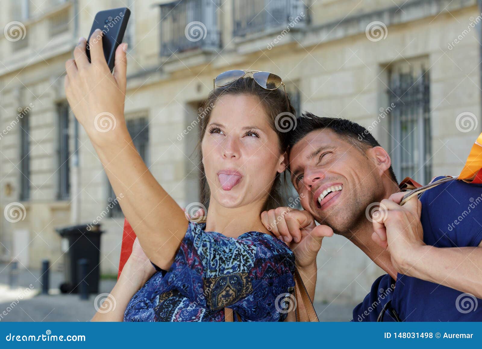 Happy Couple Taking Wacky Selfie Stock Photo - Image of mall, hugging ...
