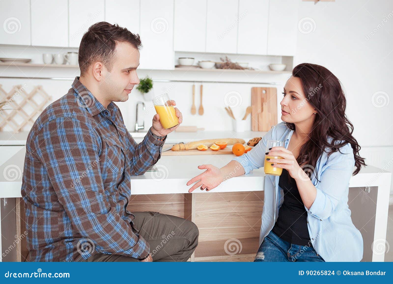 Happy Couple Talking Sitting in the Kitchen at Breakfast Stock Photo ...