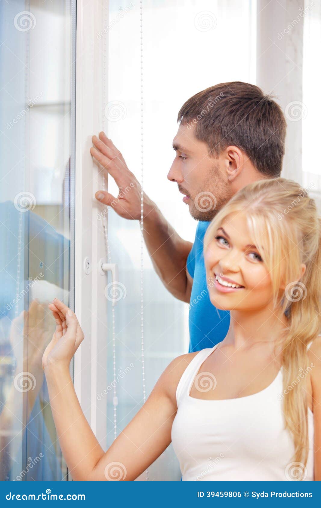 Happy couple at the window stock photo. Image of lifestyle - 39459806