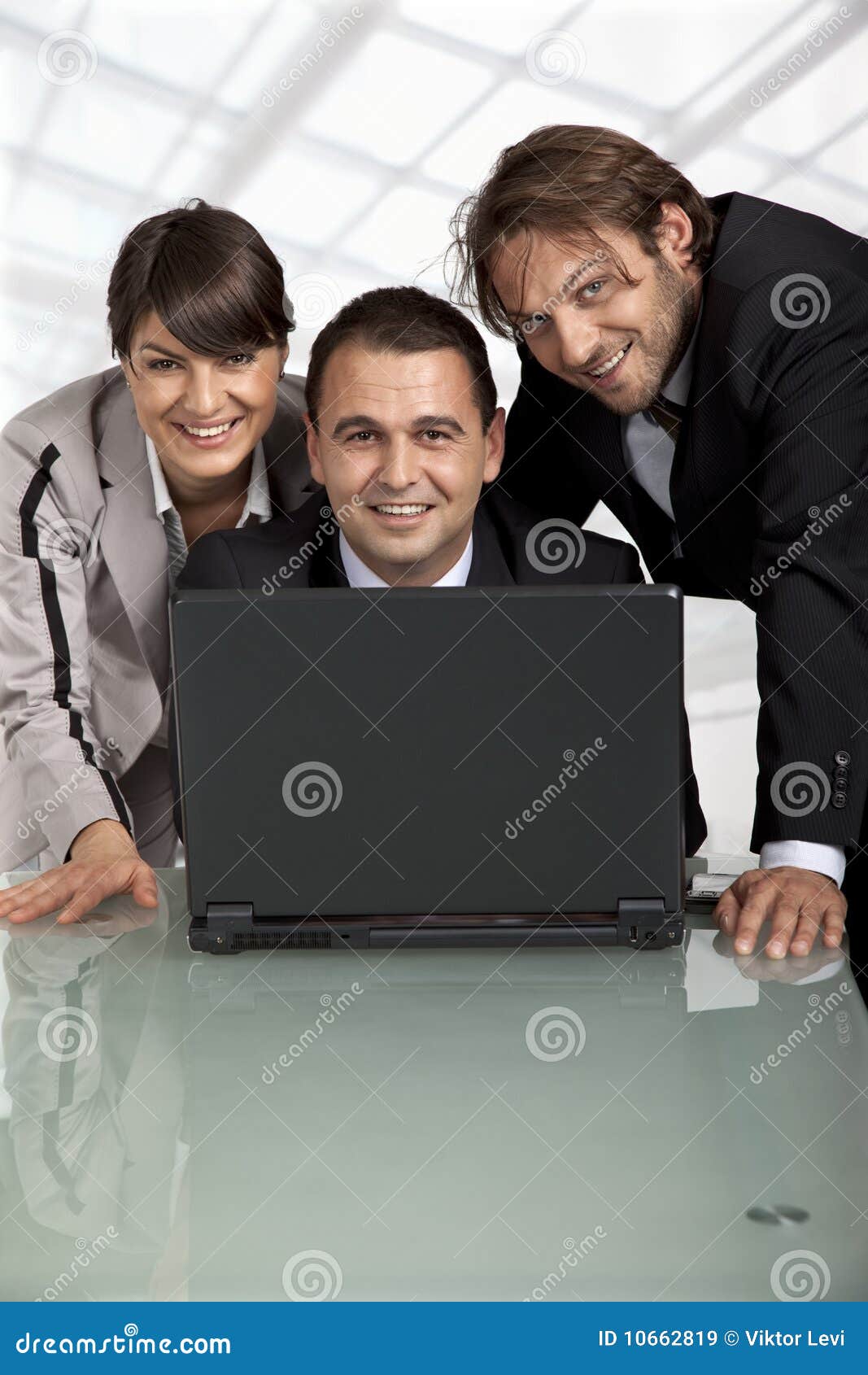 Happy Coworkers Behind a Laptop Stock Image - Image of cooperation ...