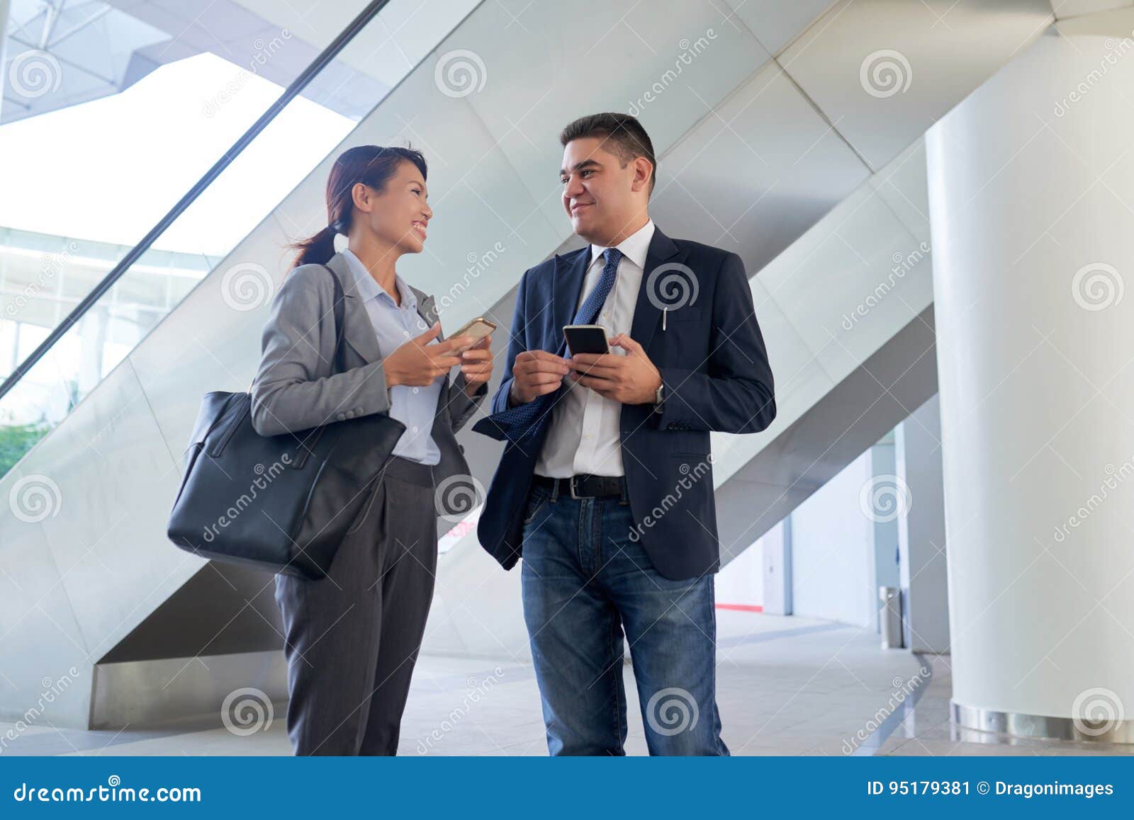 Happy coworkers stock image. Image of multiethnic, smartphone - 95179381