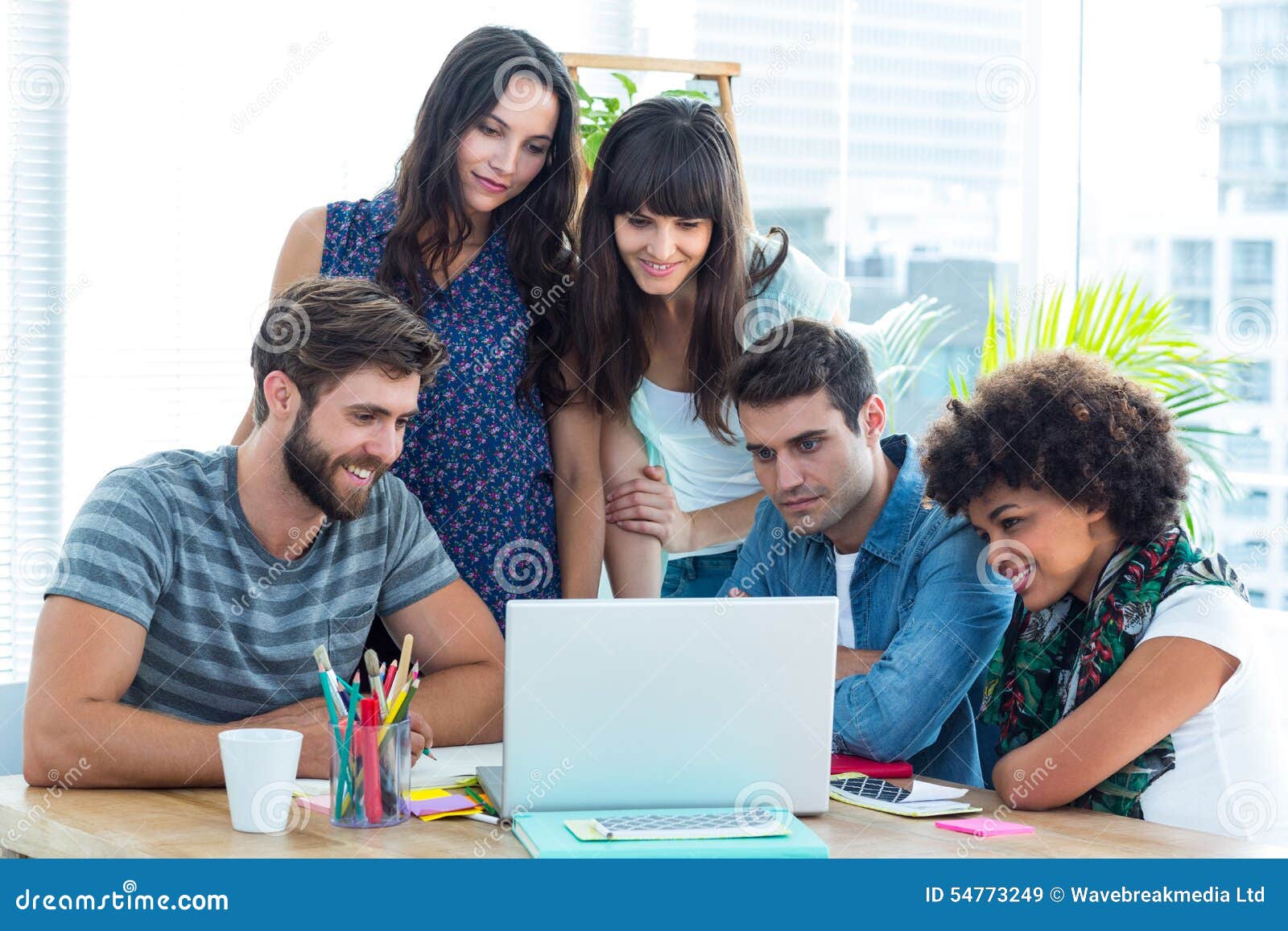 Happy Creative Business Team Gathered Around a Laptop Stock Image ...