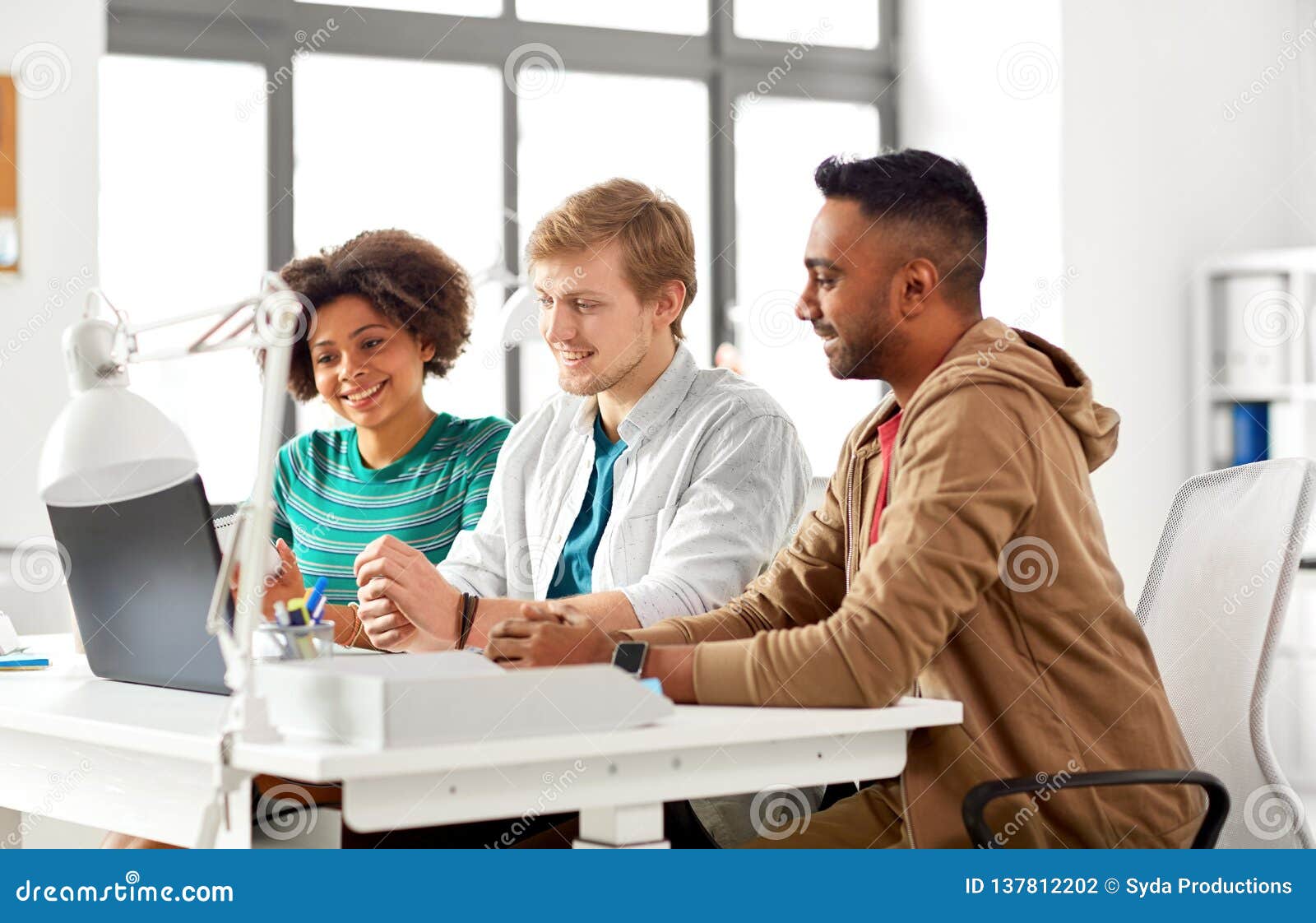 Happy Creative Team with Laptop Working at Office Stock Photo - Image ...