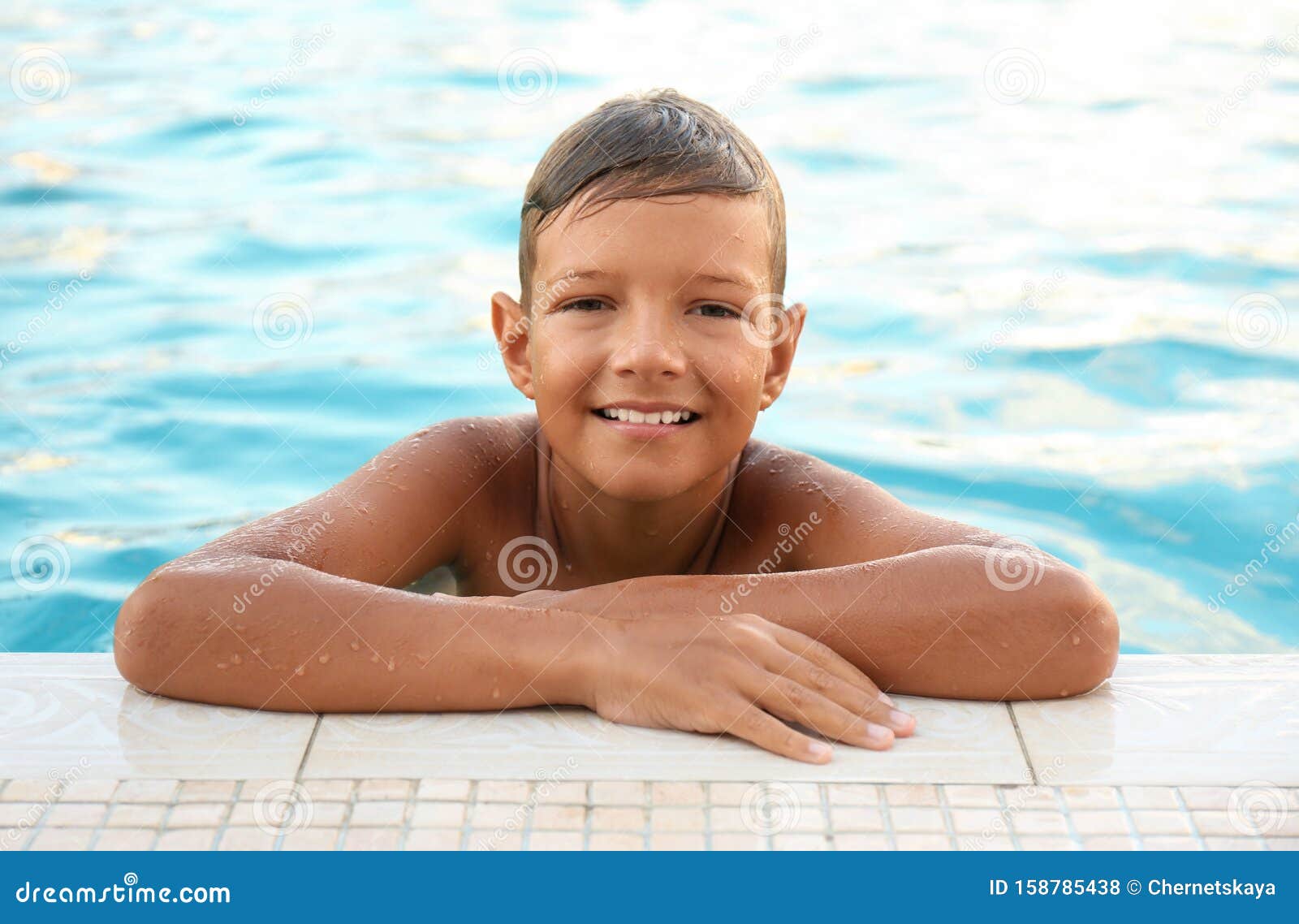 Happy boy in swimming pool stock photo. Image of green - 158785438