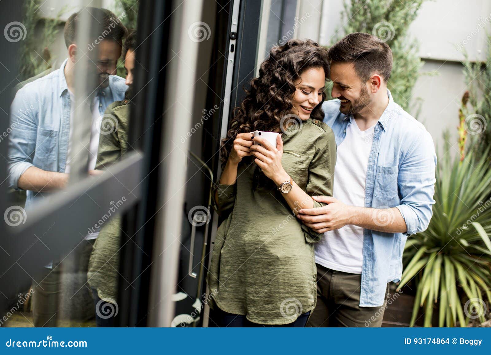 Happy Cute Couple In Love Embracing Each Other And Drinking Coffee