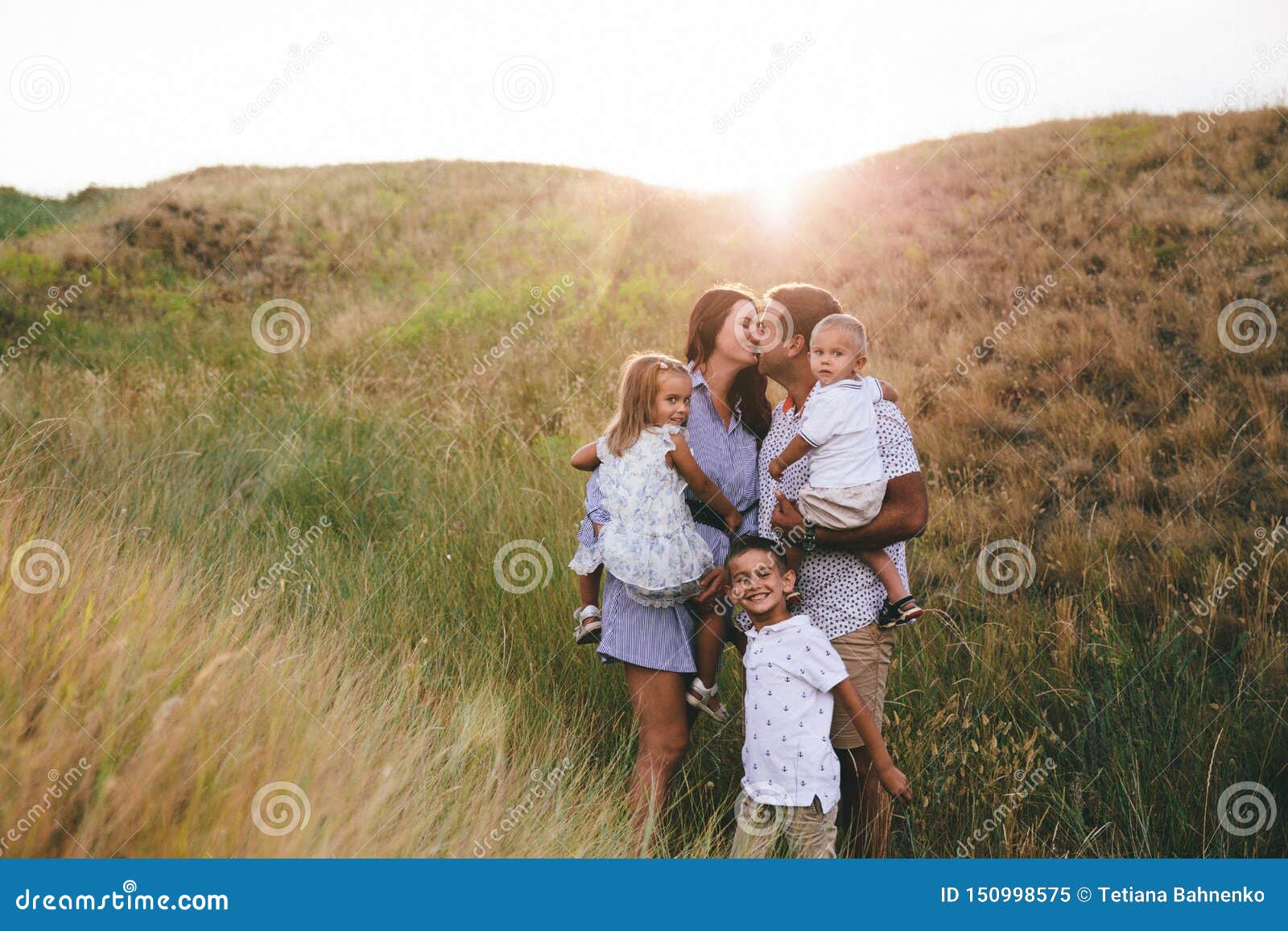 Happy Dad and Children Hugging and Having Fun Outdoors in a Wheat Field ...