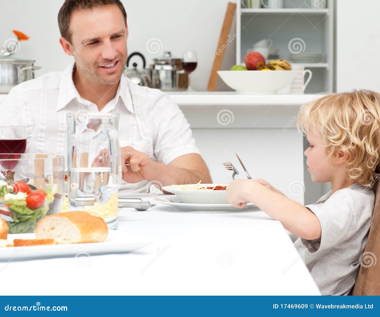 Happy Dad Looking at His Son Eating Pasta Stock Image - Image of family ...