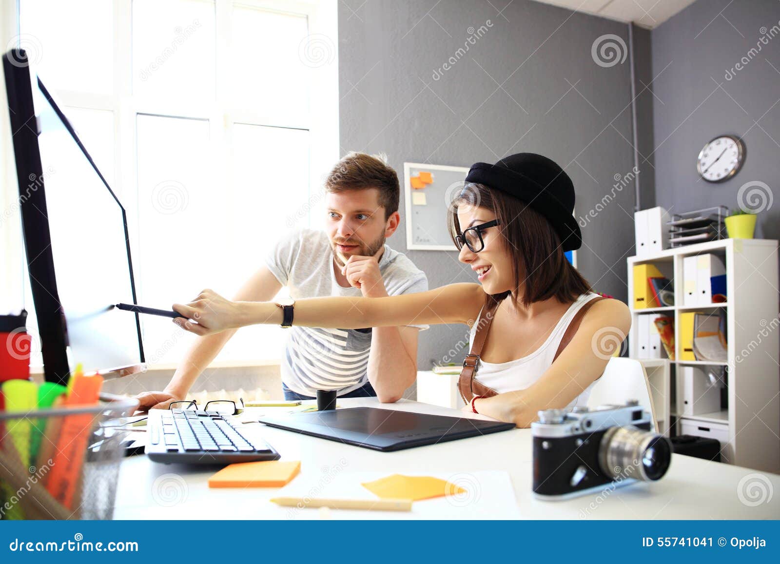 Happy Designers Working on a Document with Colleagues Working Stock ...