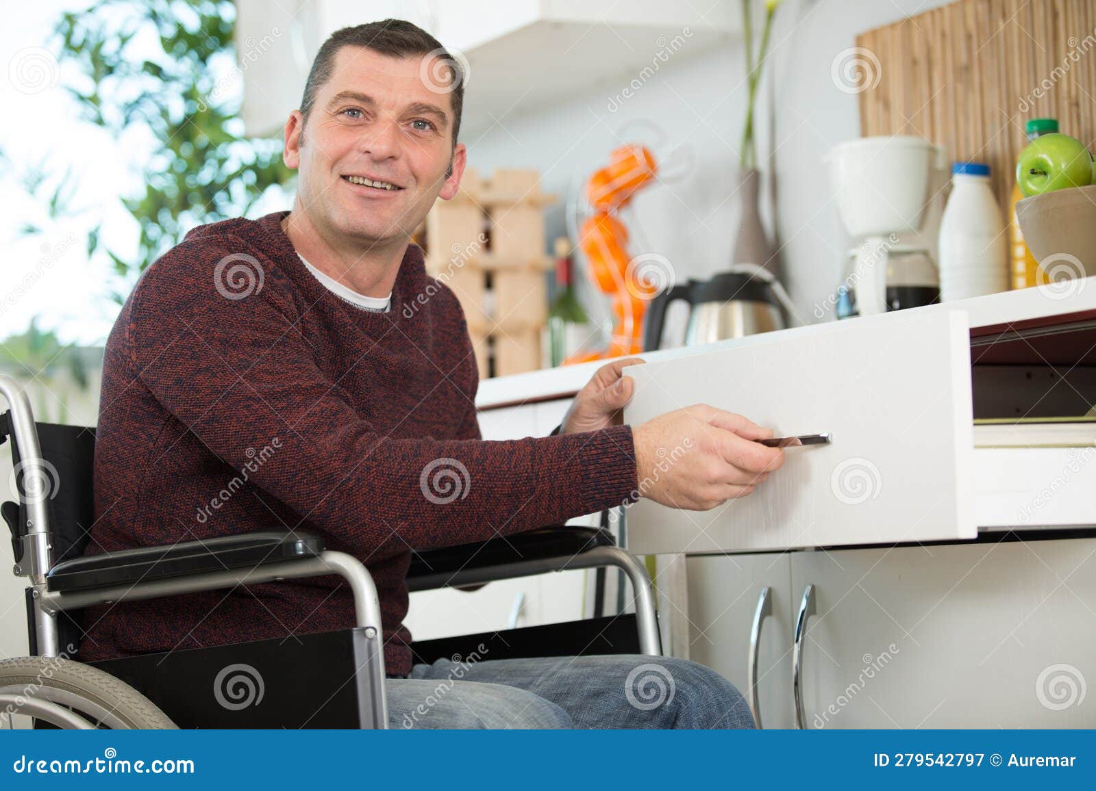 Happy Disabled Man Sitting on Wheelchair Open Drawer in Kitchen Stock ...