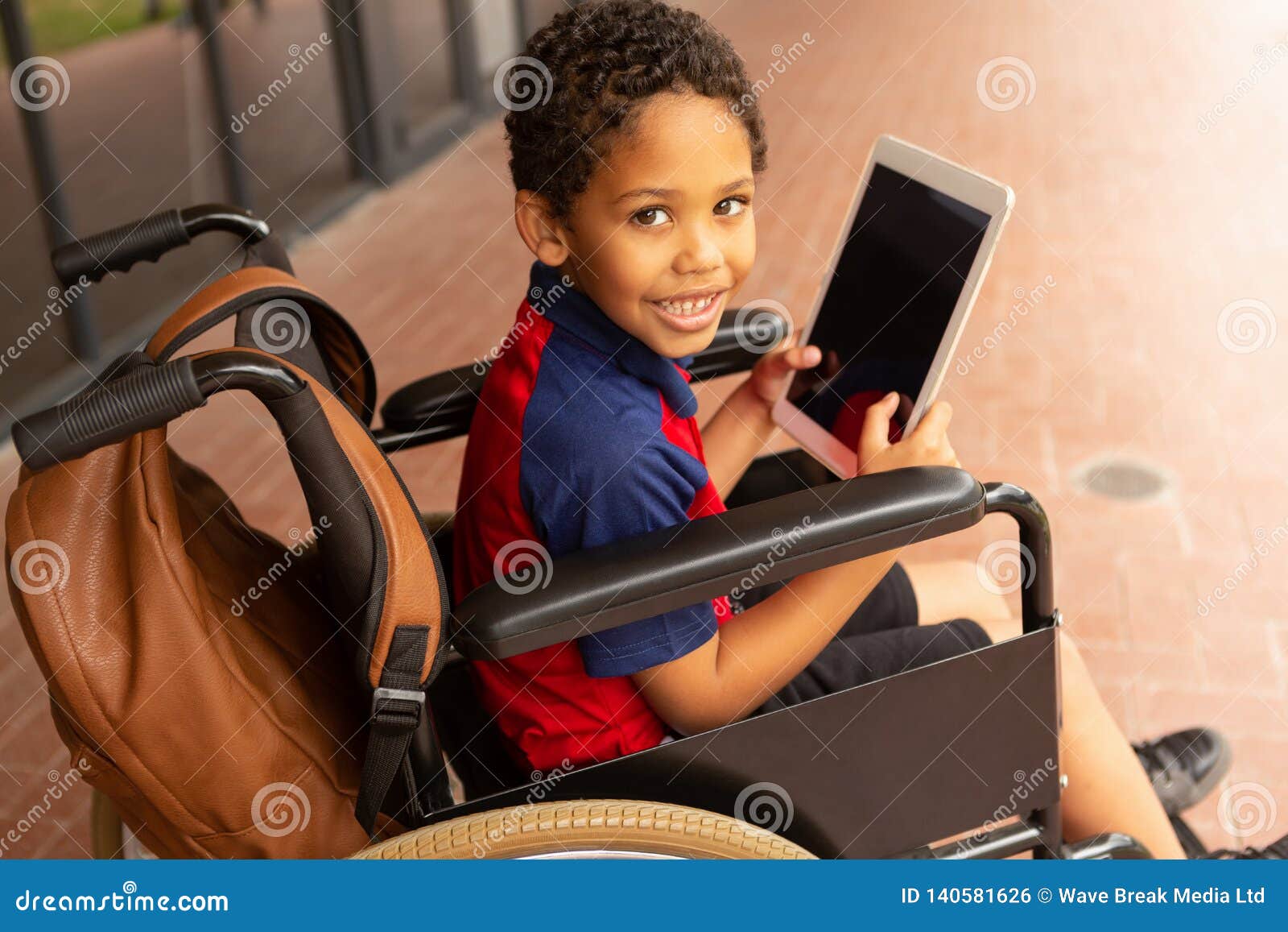 Happy Disabled Schoolboy with Digital Tablet Looking at Camera in ...