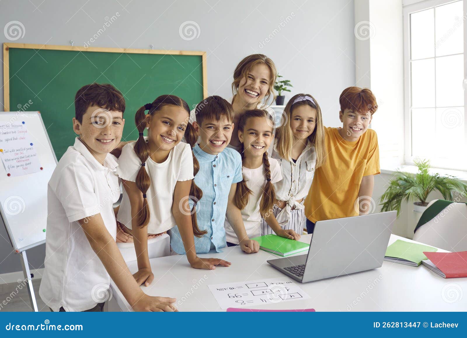 Happy Diverse Elementary School Students with Teacher Using Laptop in ...