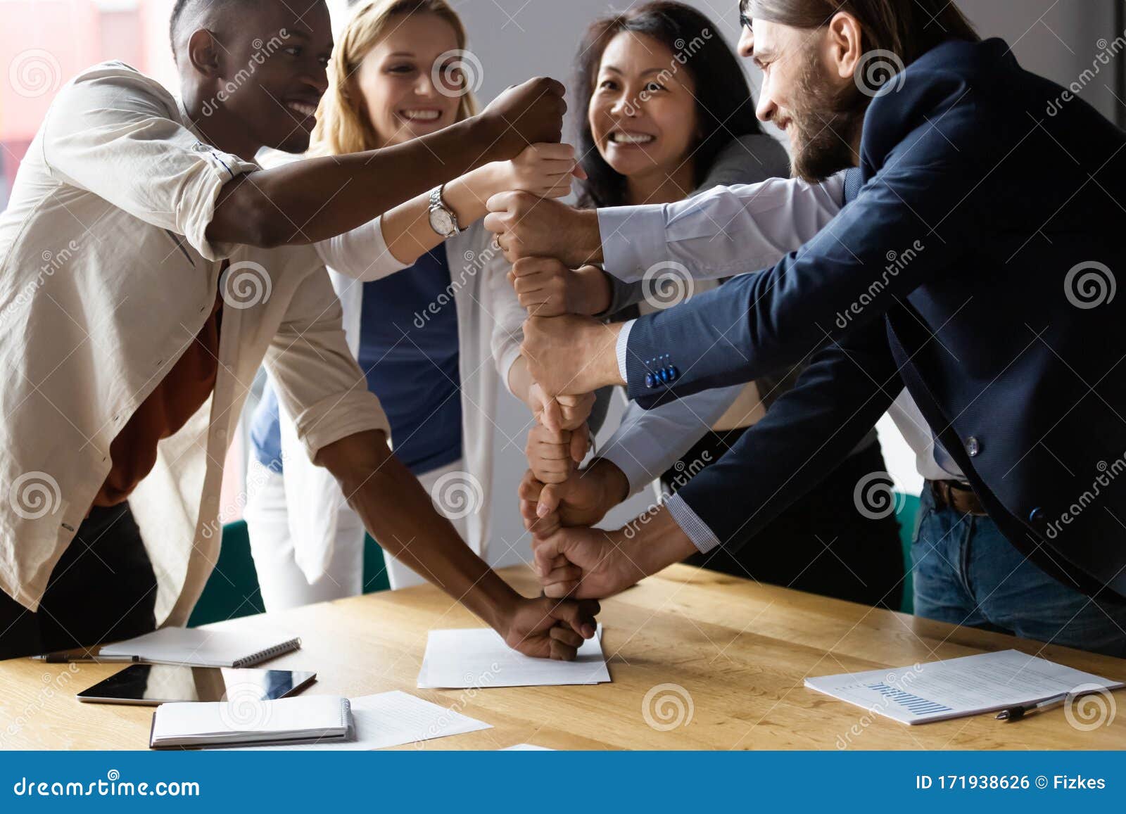 Happy Diverse Employees Stack Fists at Corporate Meeting, Celebrating ... Happy Diverse Employees Stack Fists at Corporate Meeting, Celebrating ...