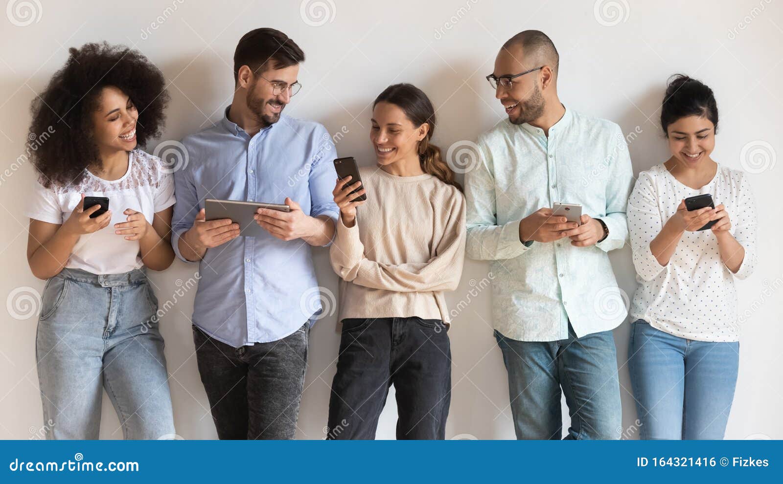 Happy Diverse Young People Using Different Electronic Devices. Stock ...
